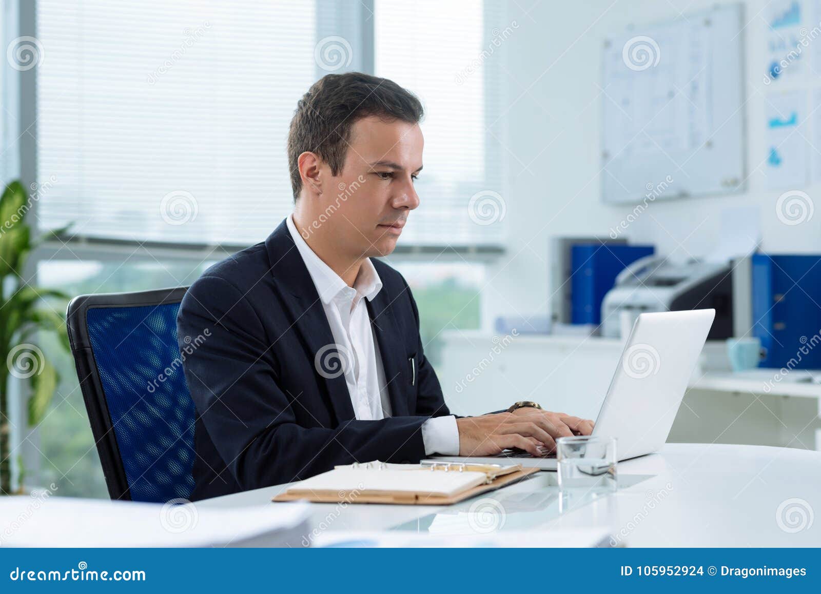 Working on laptop at table stock photo. Image of workplace - 105952924