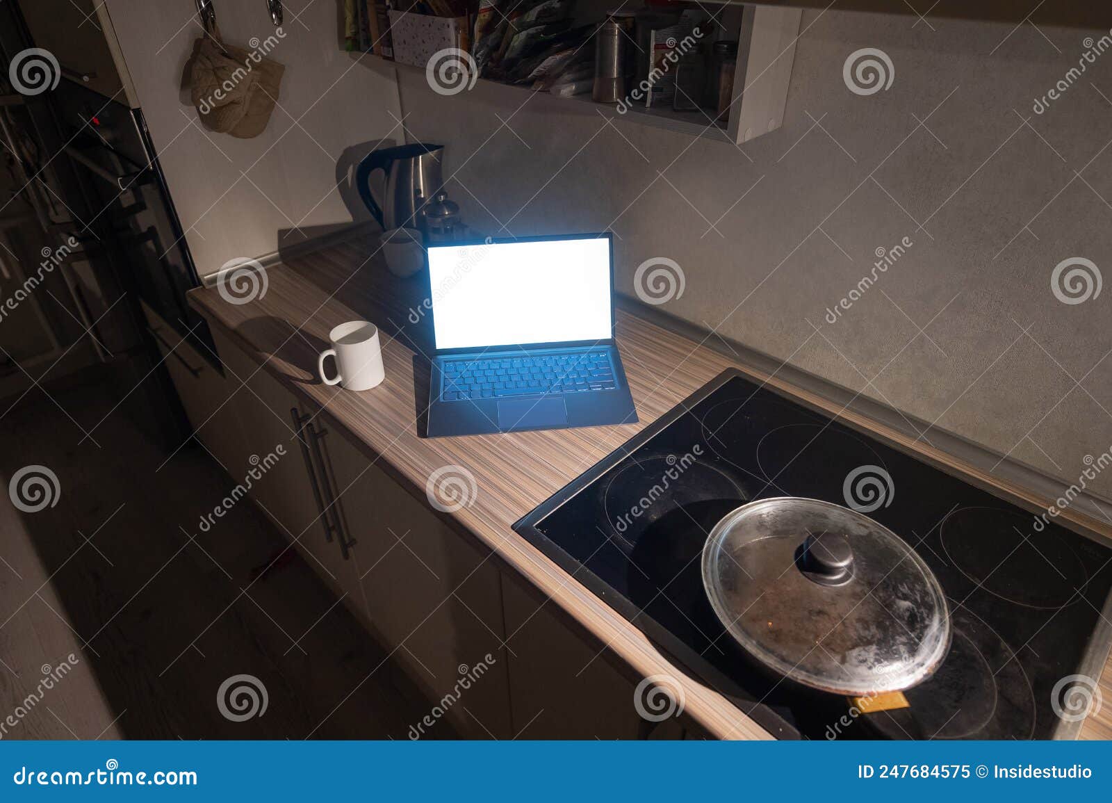 A Working Laptop with a White Screen Stands on the Kitchen Table Next ...