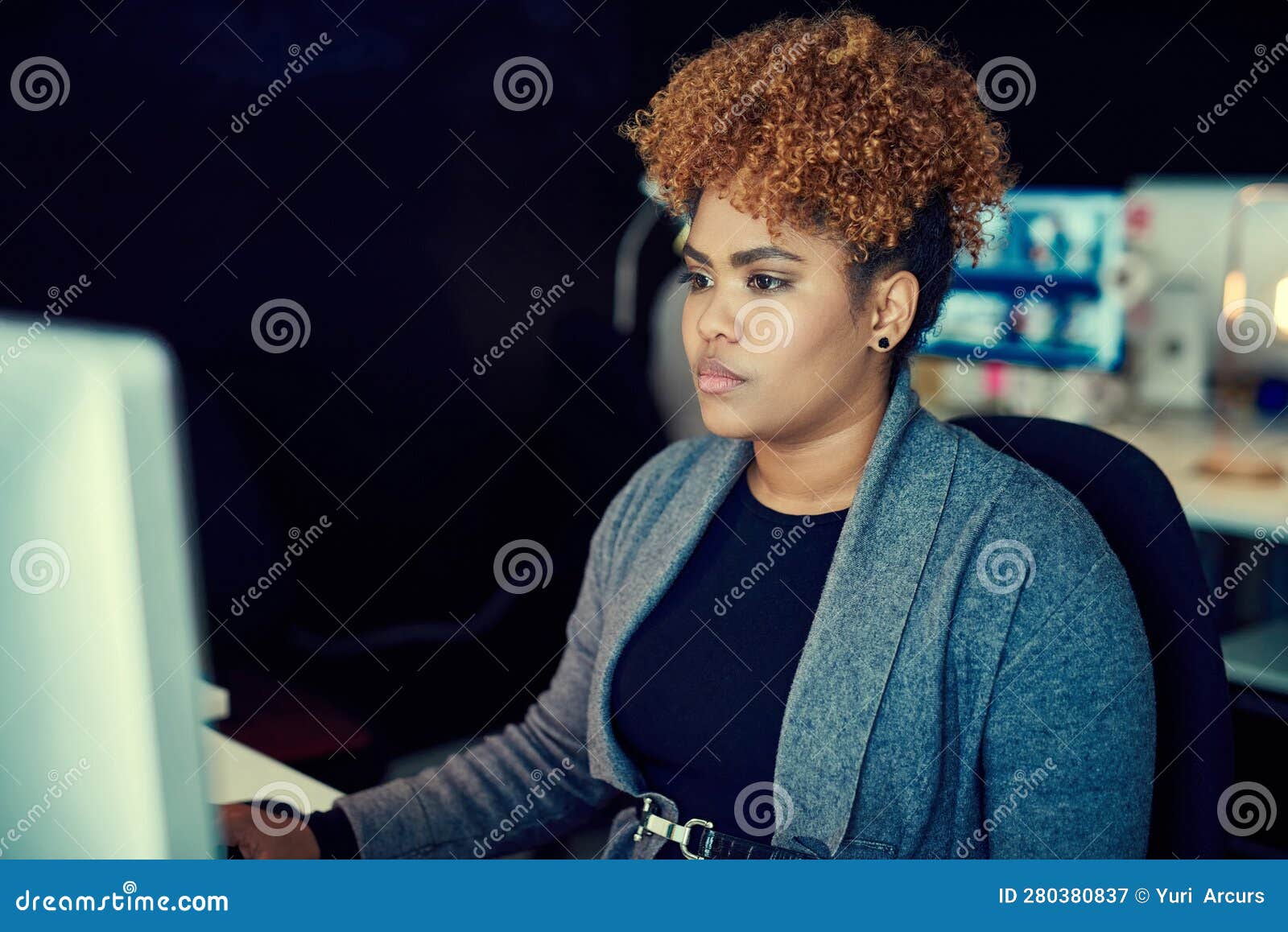 Working the Late Shift. a Young Businesswoman Working Late in an Office ...