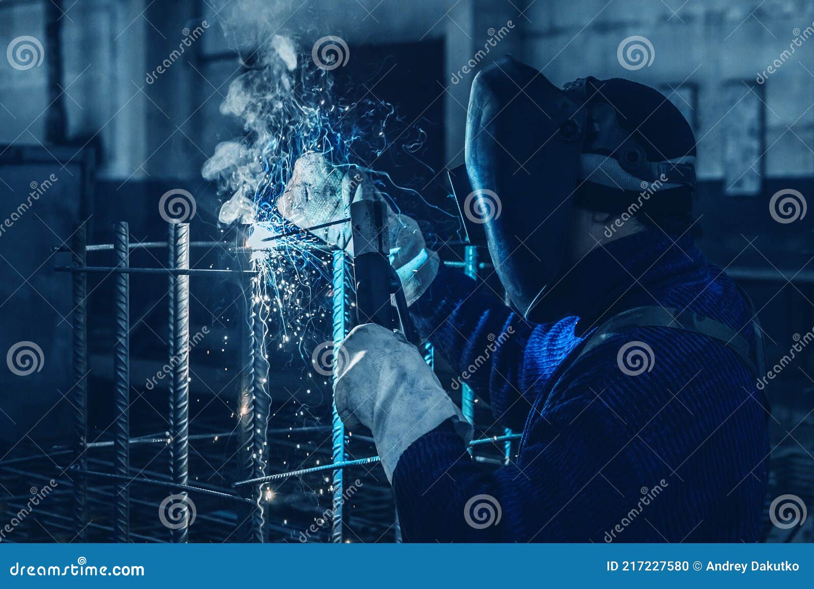 Working Man is Doing Welding Work on Metal Structures in a Factory or ...