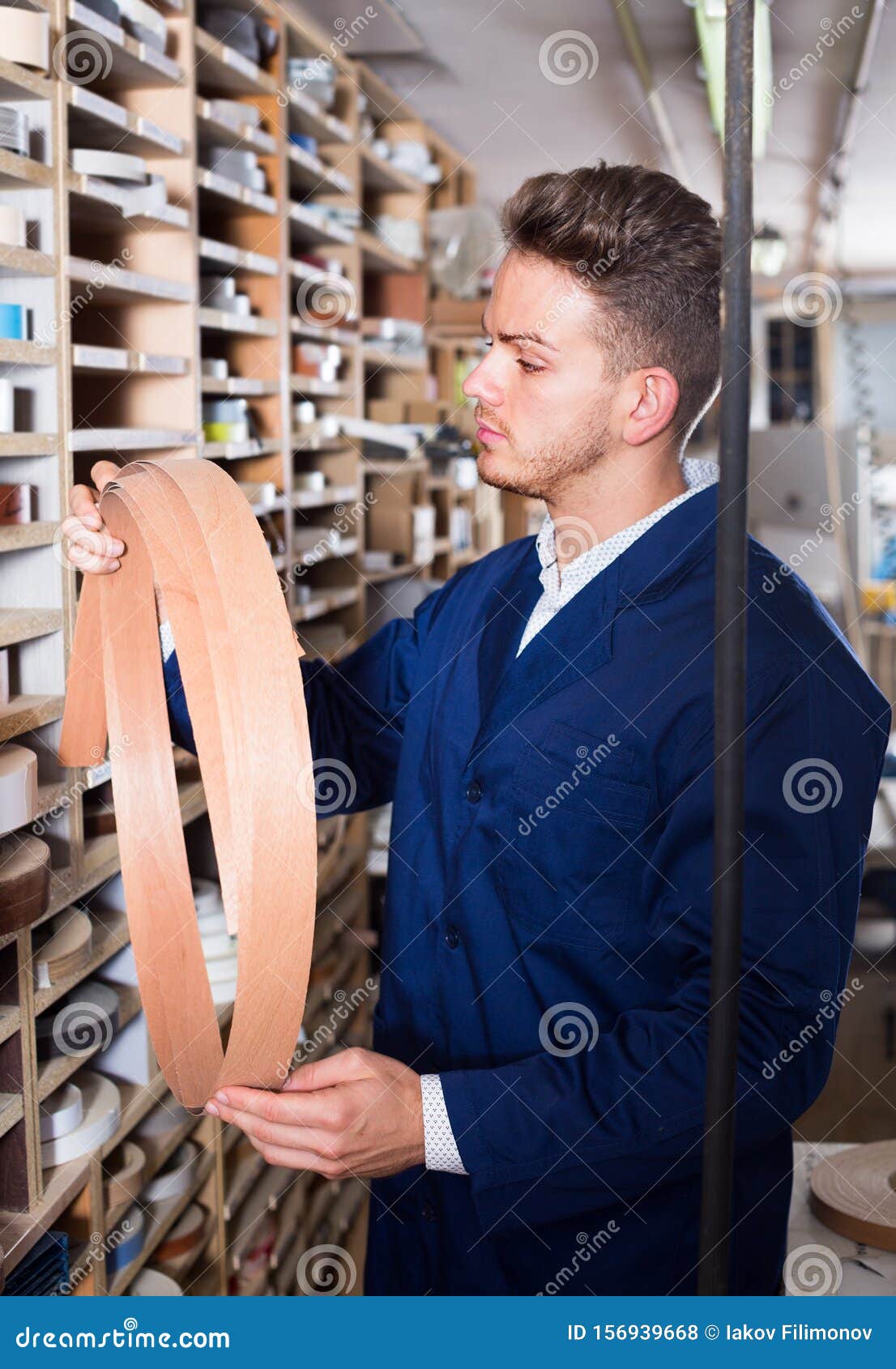 Working Man Examining Edging Strips To Finish Work Stock Photo - Image ...