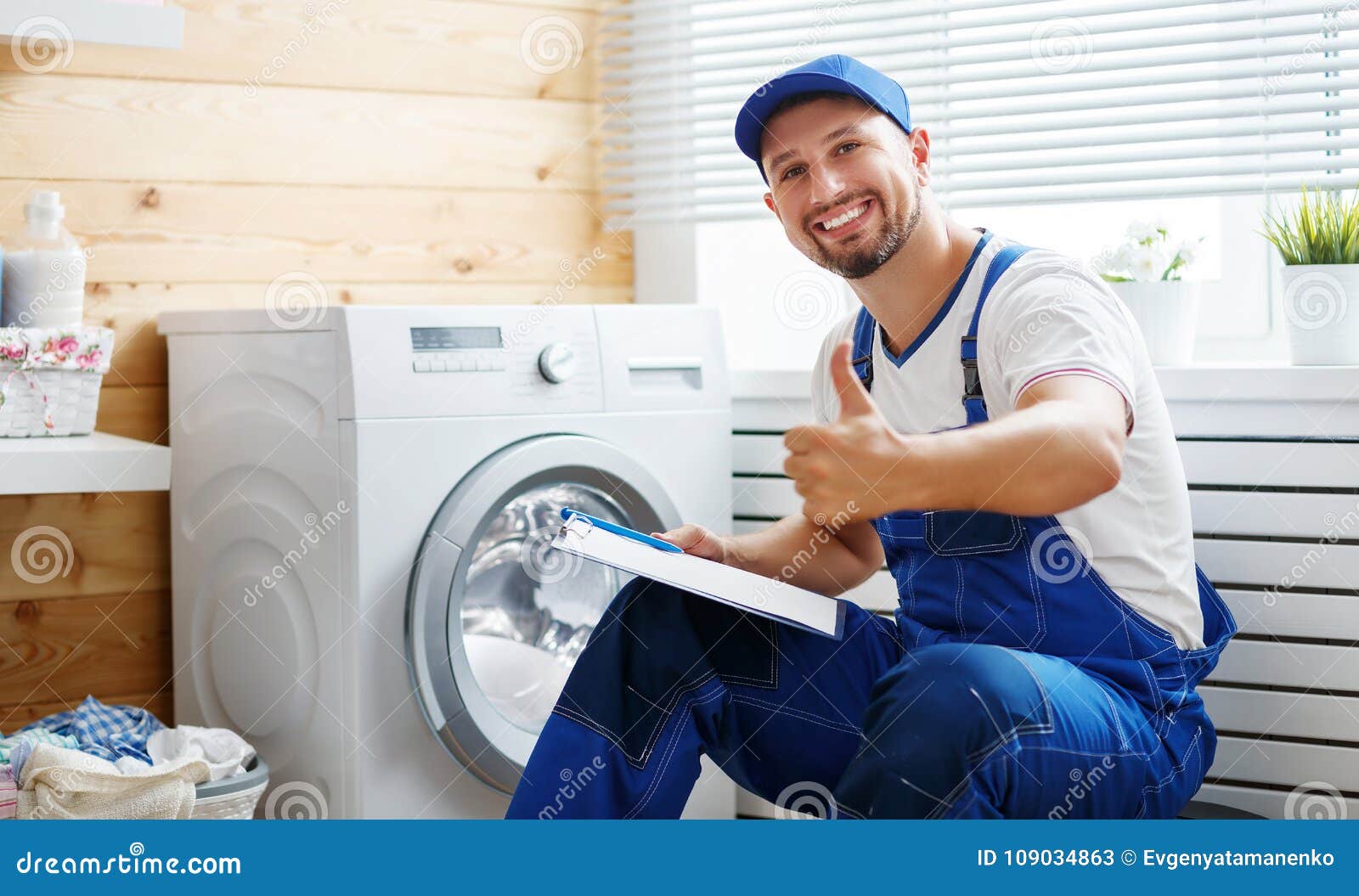 Working Man Plumber Repairs Washing Machine in Laundry Stock Image ...