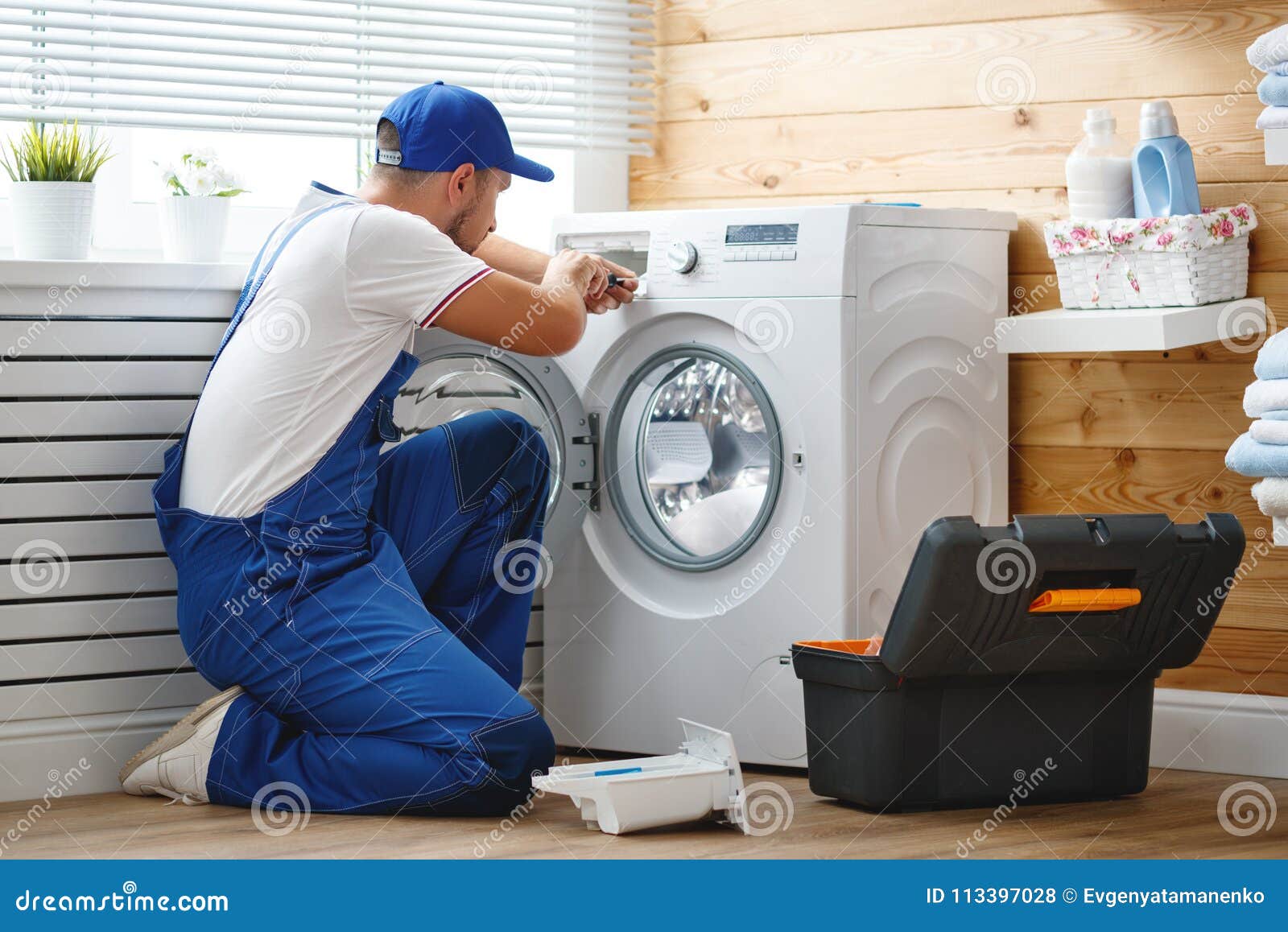 Working Man Plumber Repairs Washing Machine in Laundry Stock Photo ...