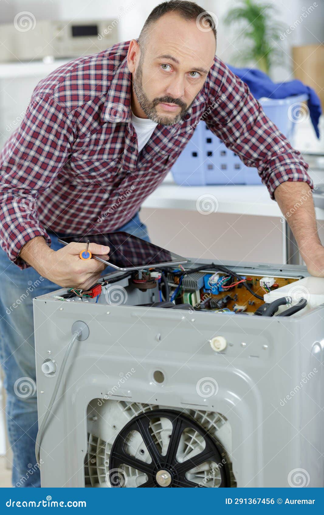 Working Man Plumber Repairs Washing Machine in Laundry Stock Photo ...