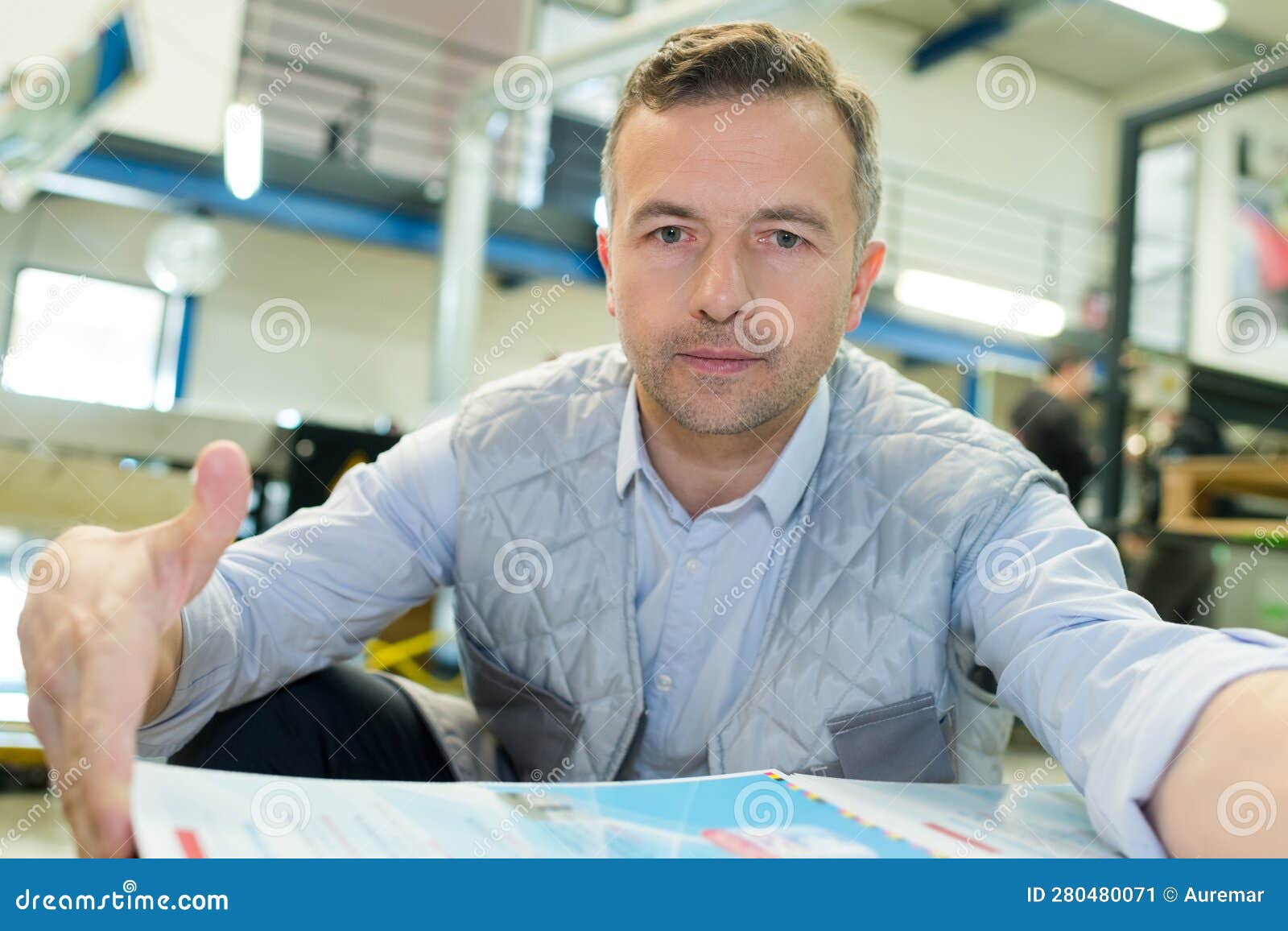 Working Man Tidying Papers in Industrial Premises Stock Image - Image ...