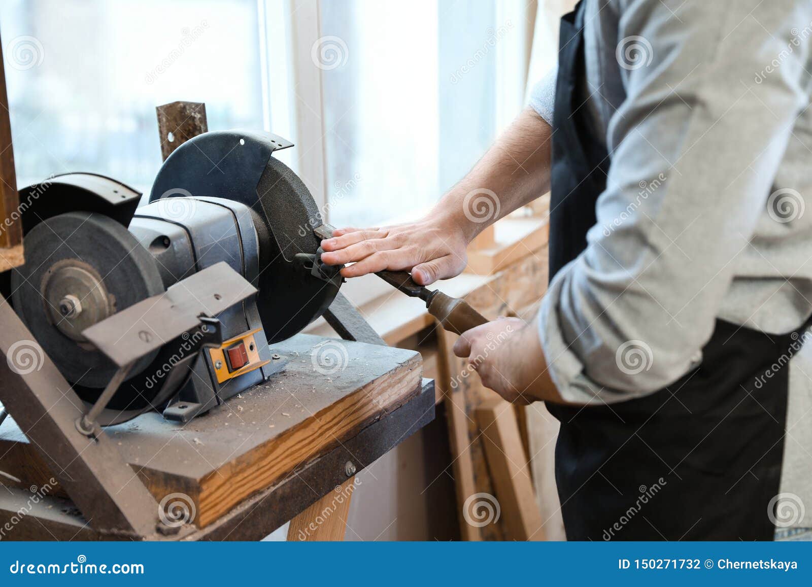 Working Man Using Grinding Machine at Carpentry Shop Stock Photo ...