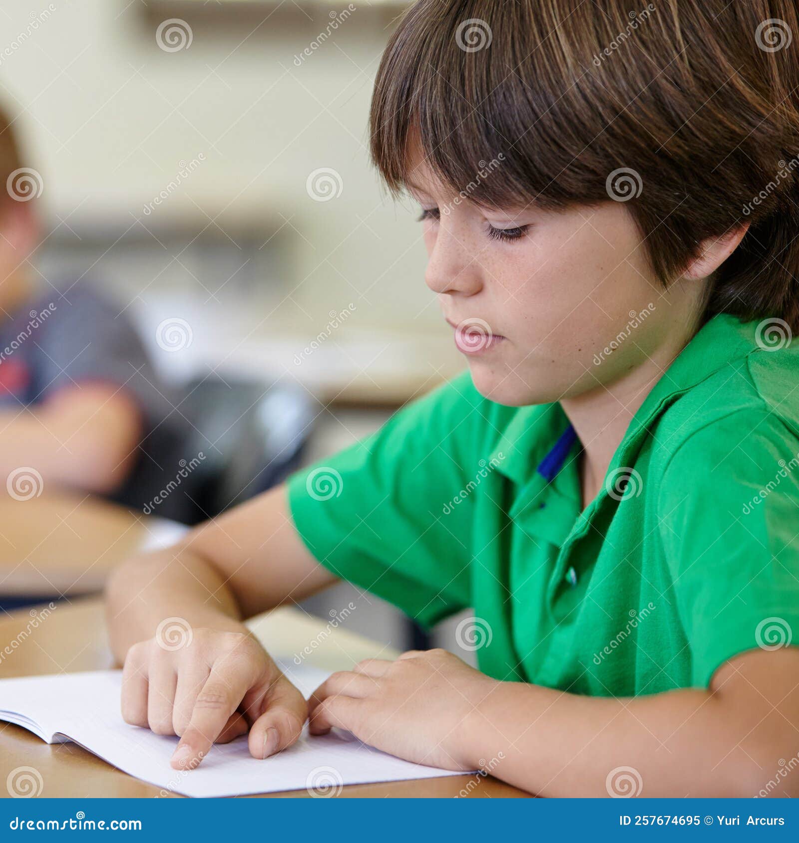 Working through a Maths Problem. a Young Student Focused on His Work ...