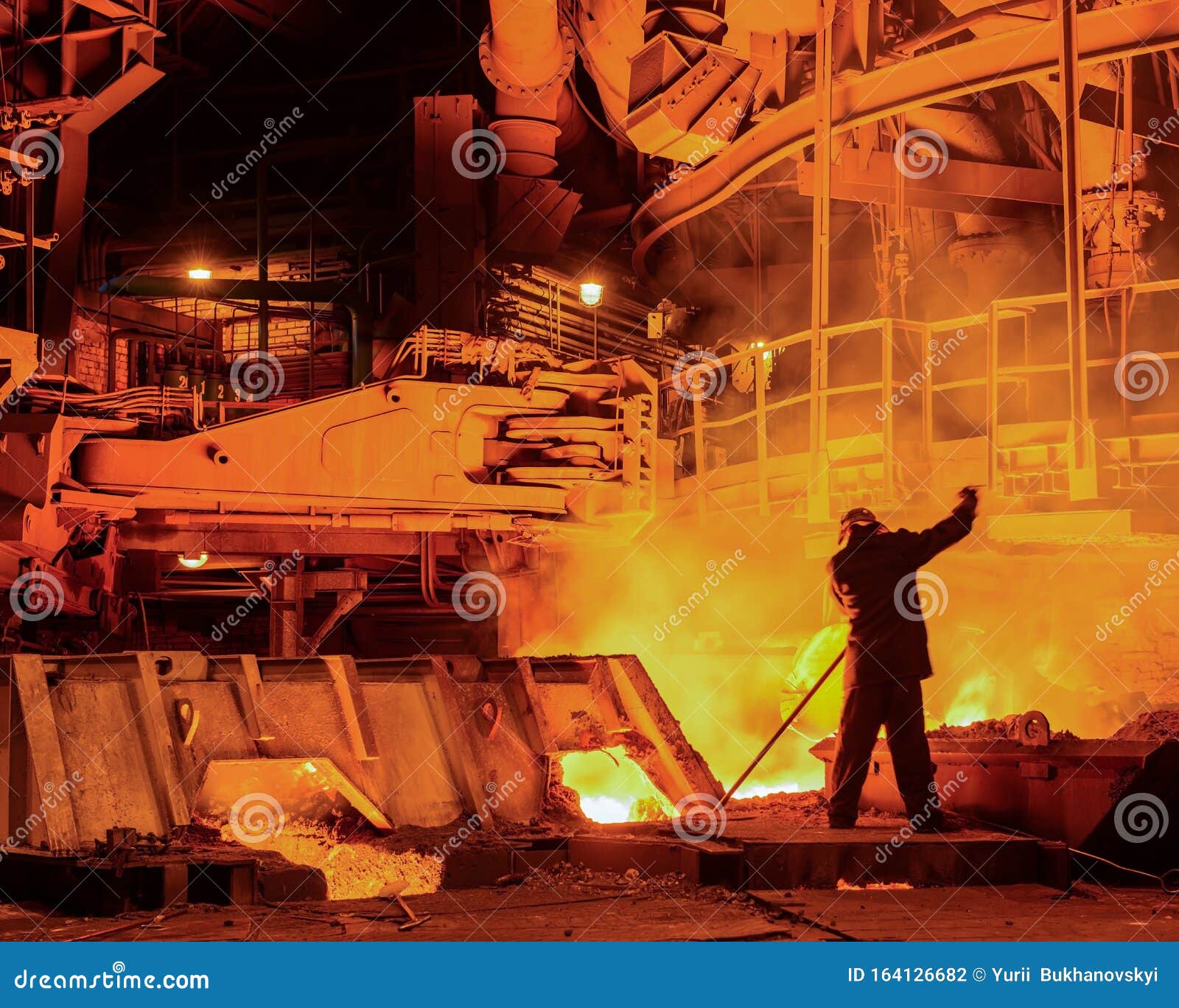 Steelworker Near a Blast Furnace with Sparks. Foundry. Heavy Industry ...