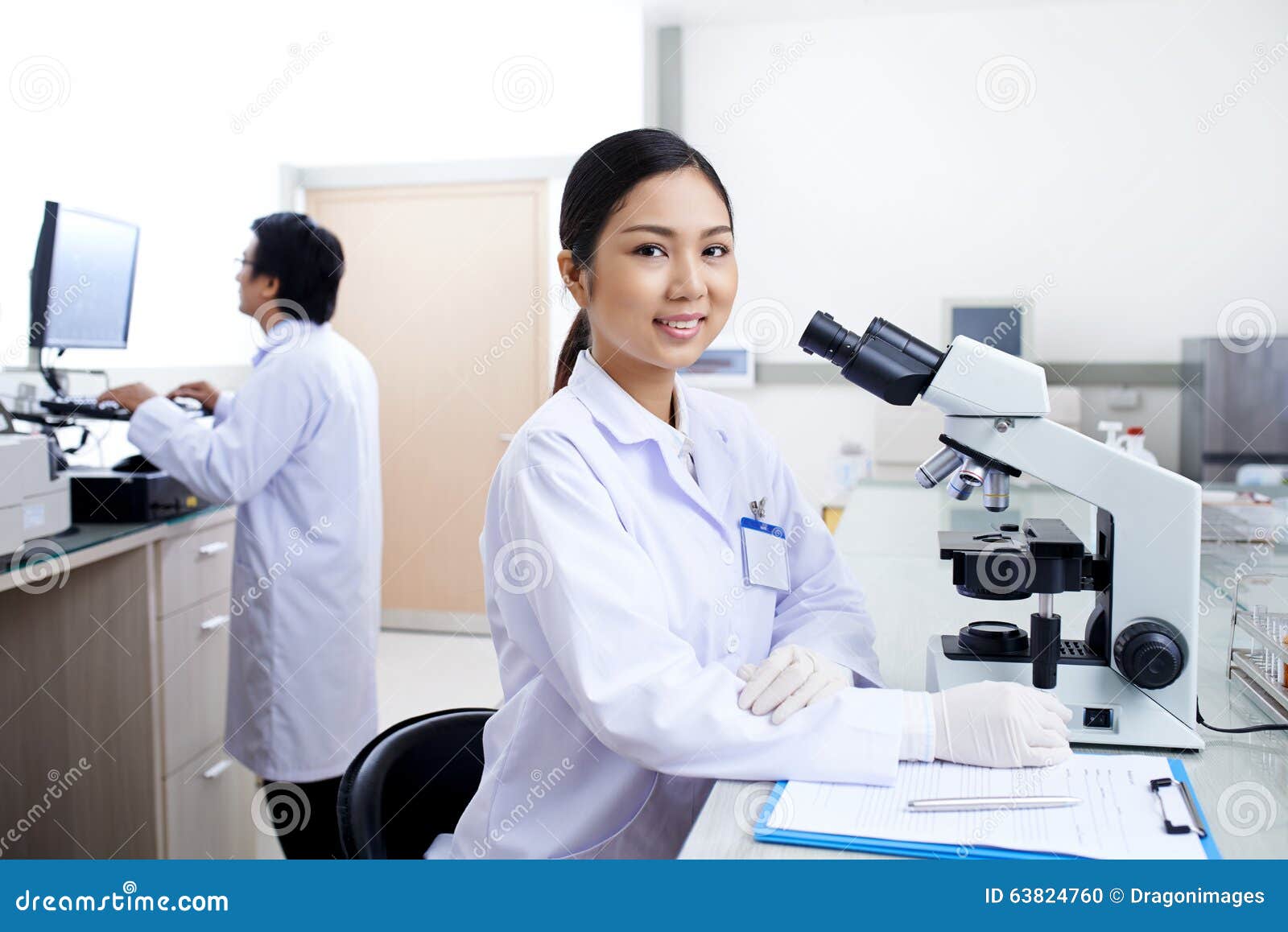 Working with microscope stock photo. Image of assistant - 63824760