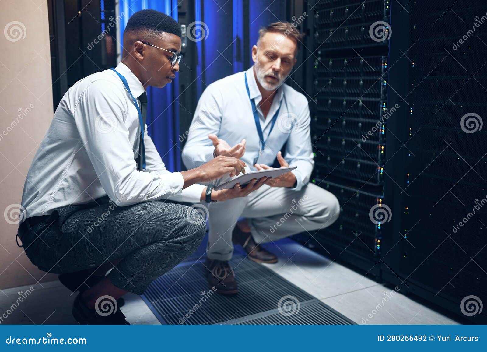 Working through Multiple Issues at a Time. Two Technicians Using a ...