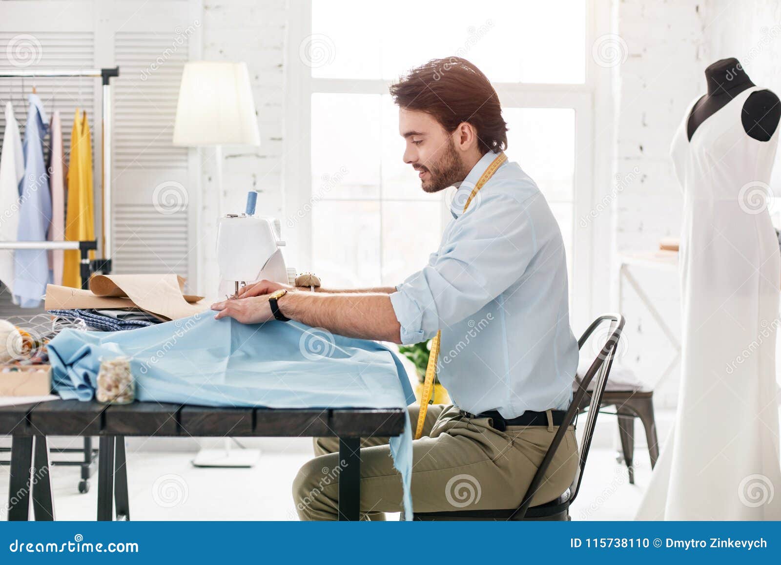 Smiling Professional Tailor Working on a Sewing Machine Stock Photo ...