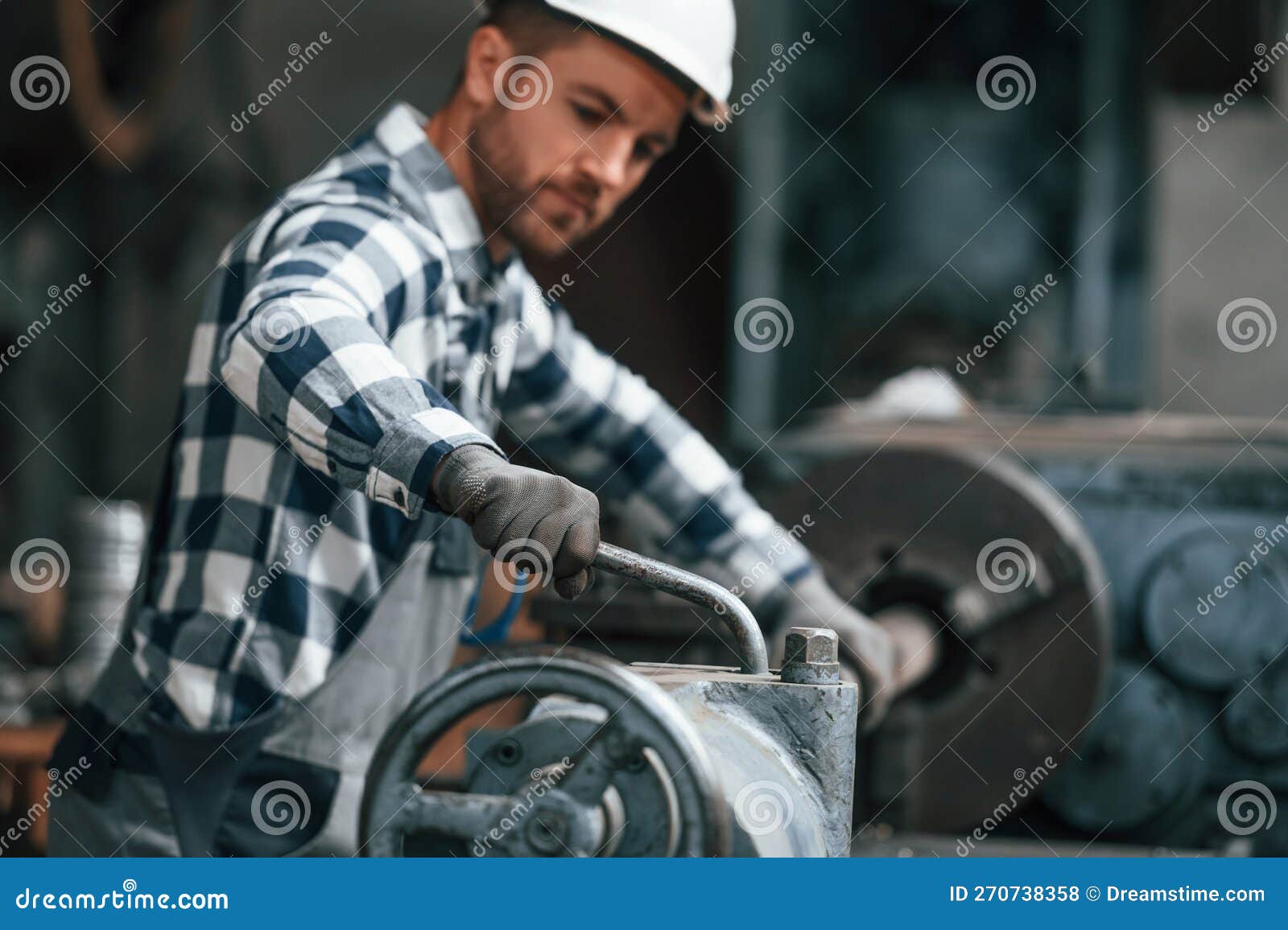 Working by Operating Machine. Factory Worker in Uniform is Indoors ...