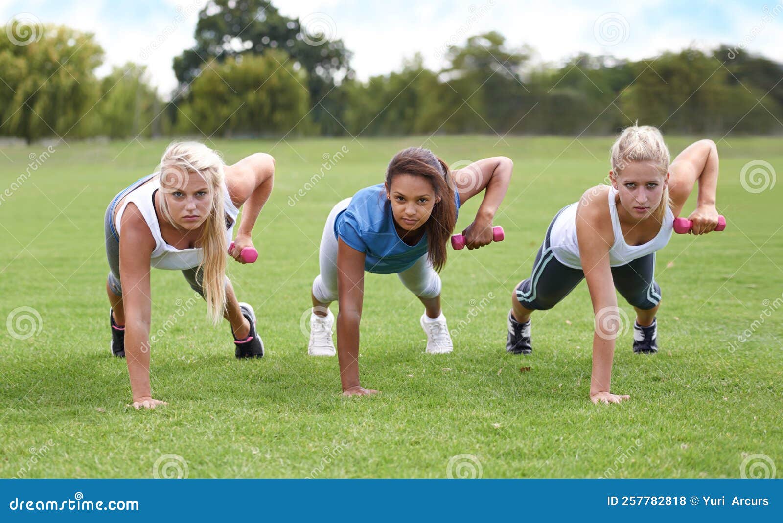 Working Out As a Team. a Group of Young Women Working Out with ...