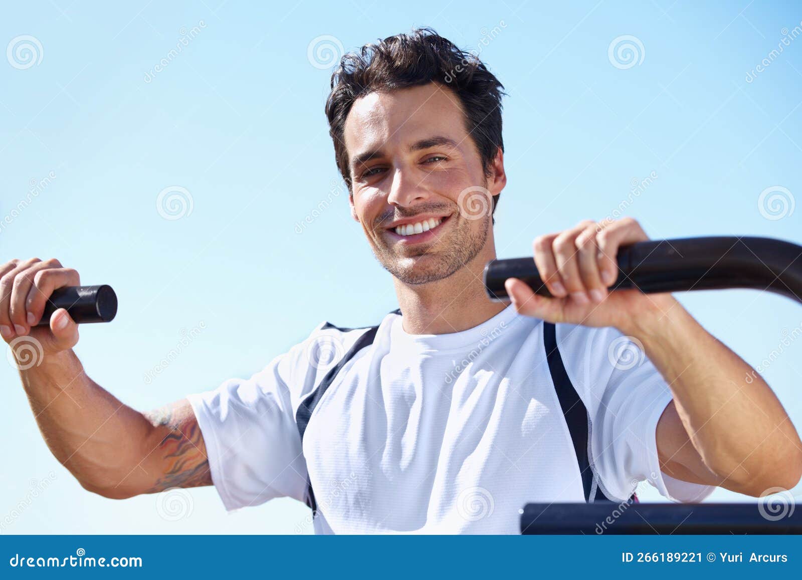 Working Out and Getting Some Sun. a Handsome Young Man Exercising ...