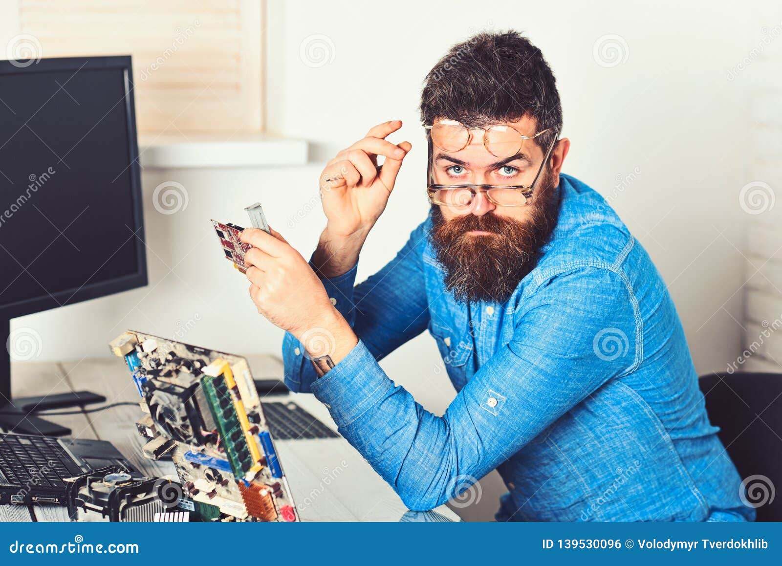 Working with Passion. Assemblying of Electronic Devices. Bearded Man ...