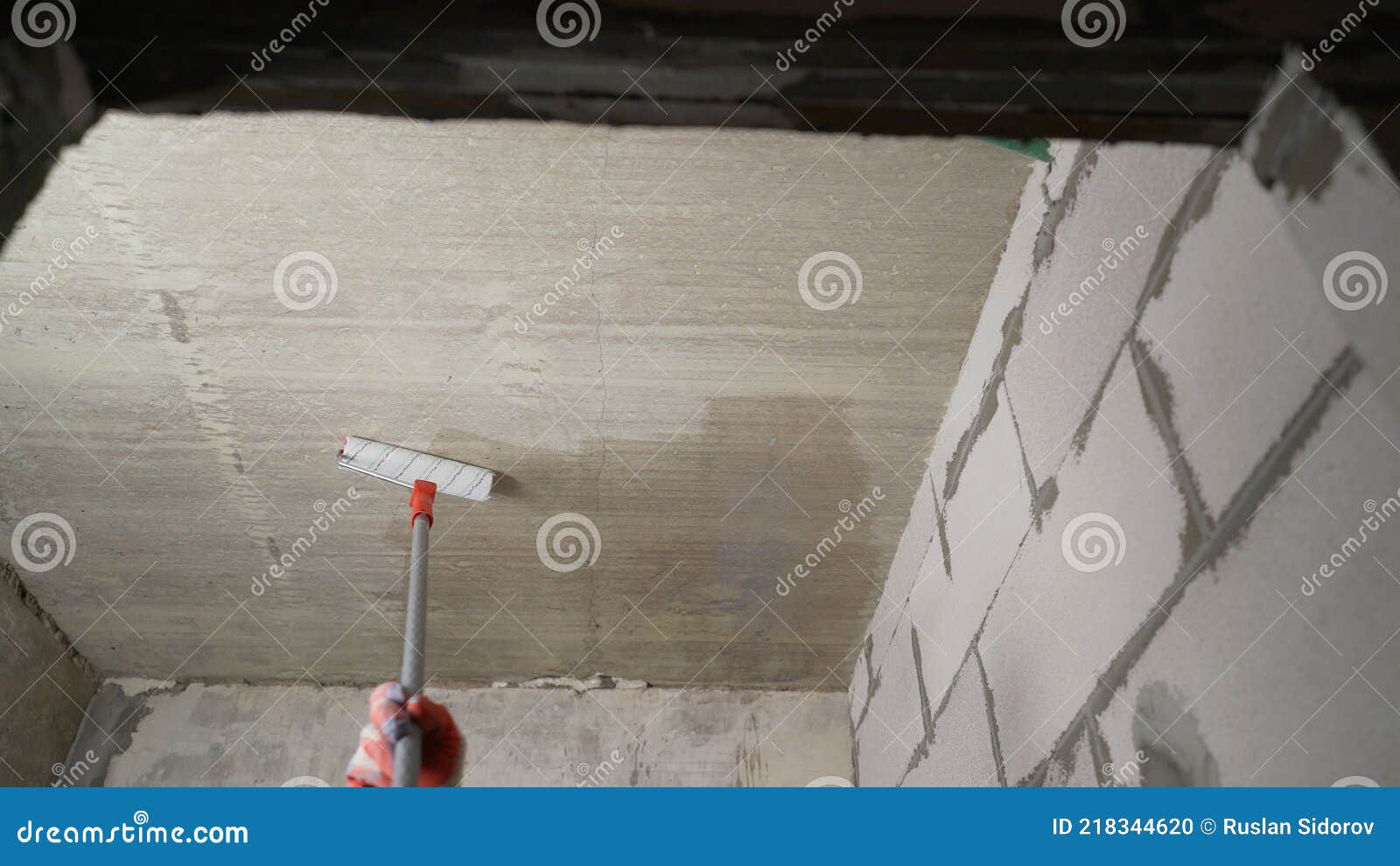 Working Primer with a Ceiling Paint Roller. Close-up of Concrete ...