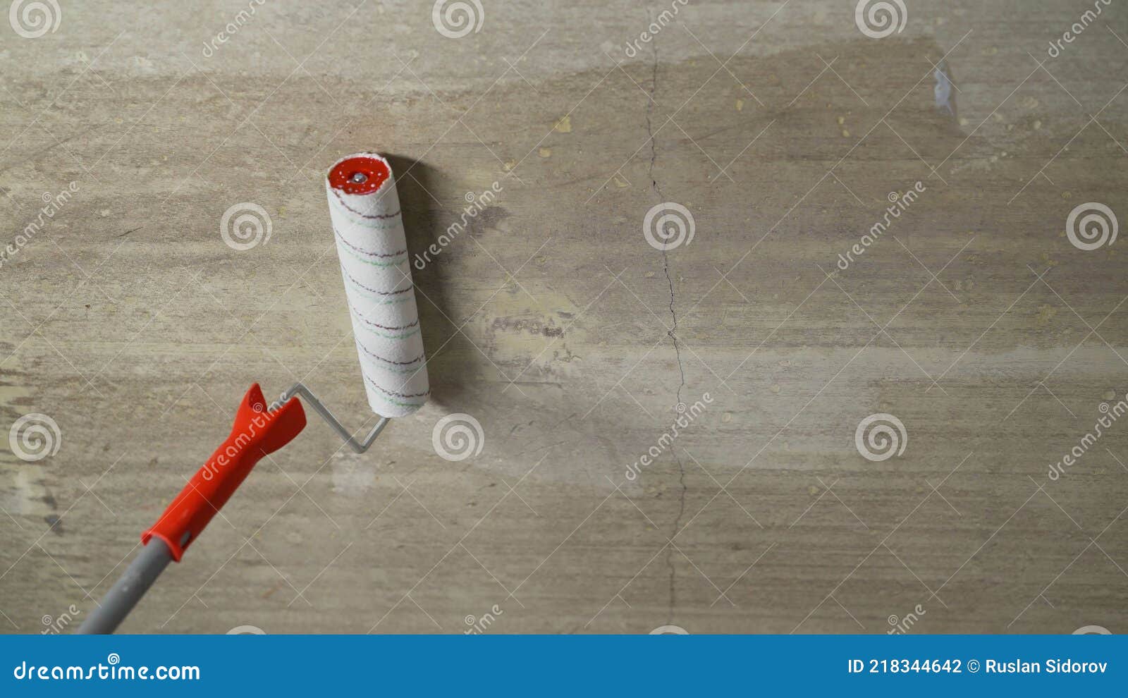 Working Primer with a Ceiling Paint Roller. Close-up of Concrete ...
