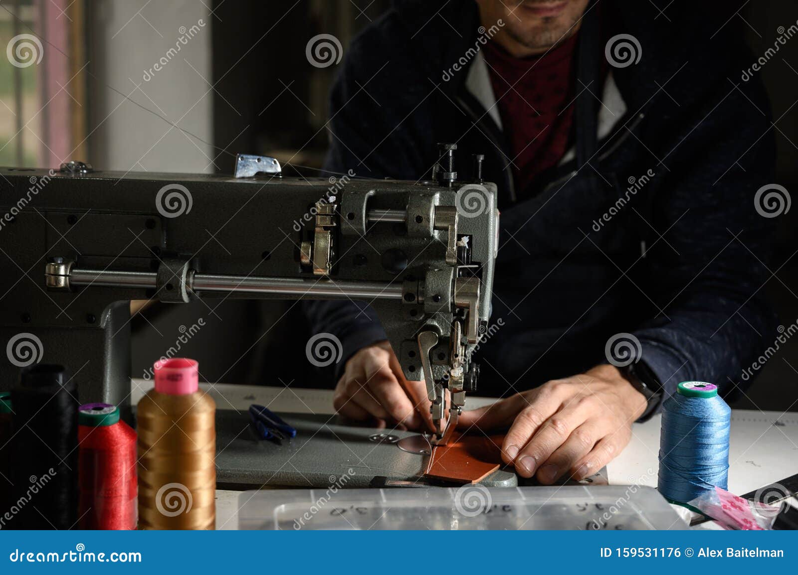 Working Process of Leather Craftsman. Tanner or Skinner Sews Leather on ...