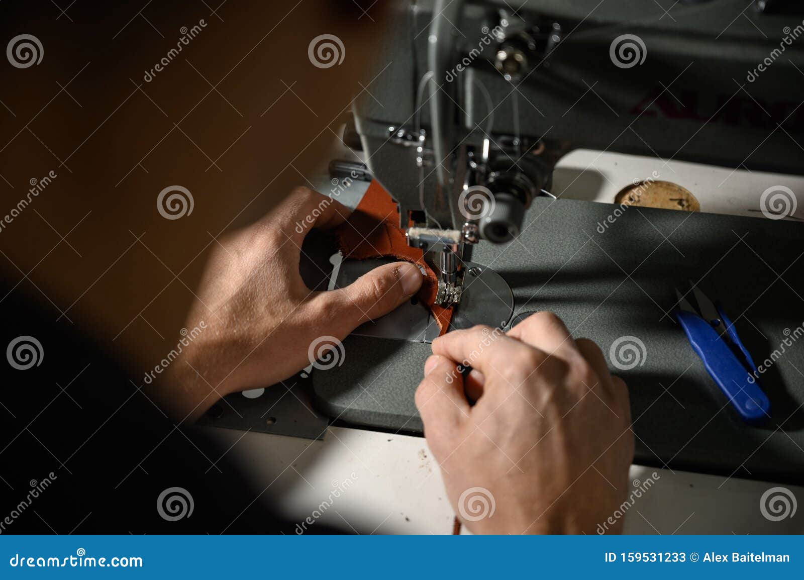 Working Process of Leather Craftsman. Tanner or Skinner Sews Leather on ...