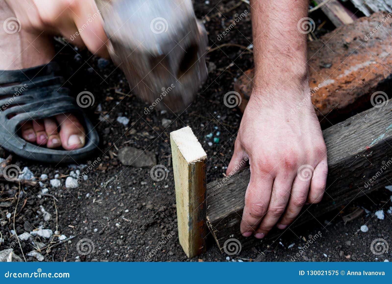 Working Process. Men`s Hands at Work. Clogging the Boards. Tools - a ...
