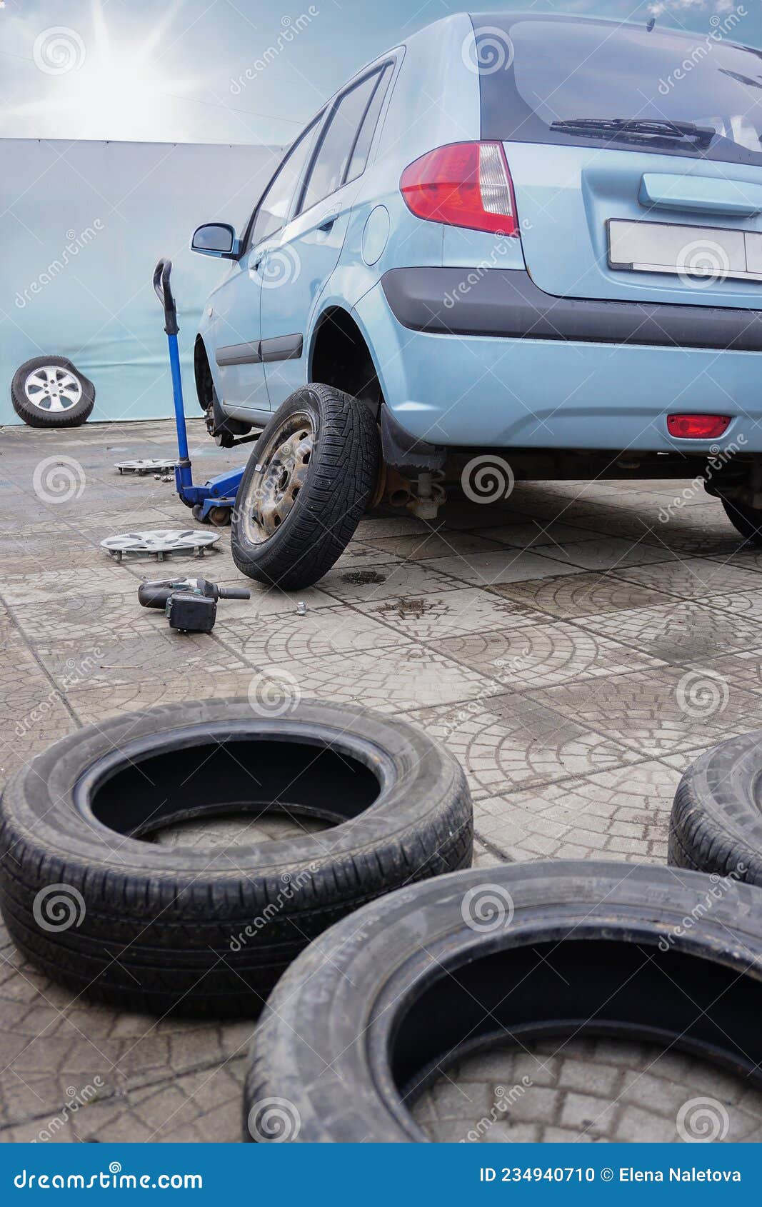 Working Process of Removing the Wheel from the Car. Replacing Summer ...