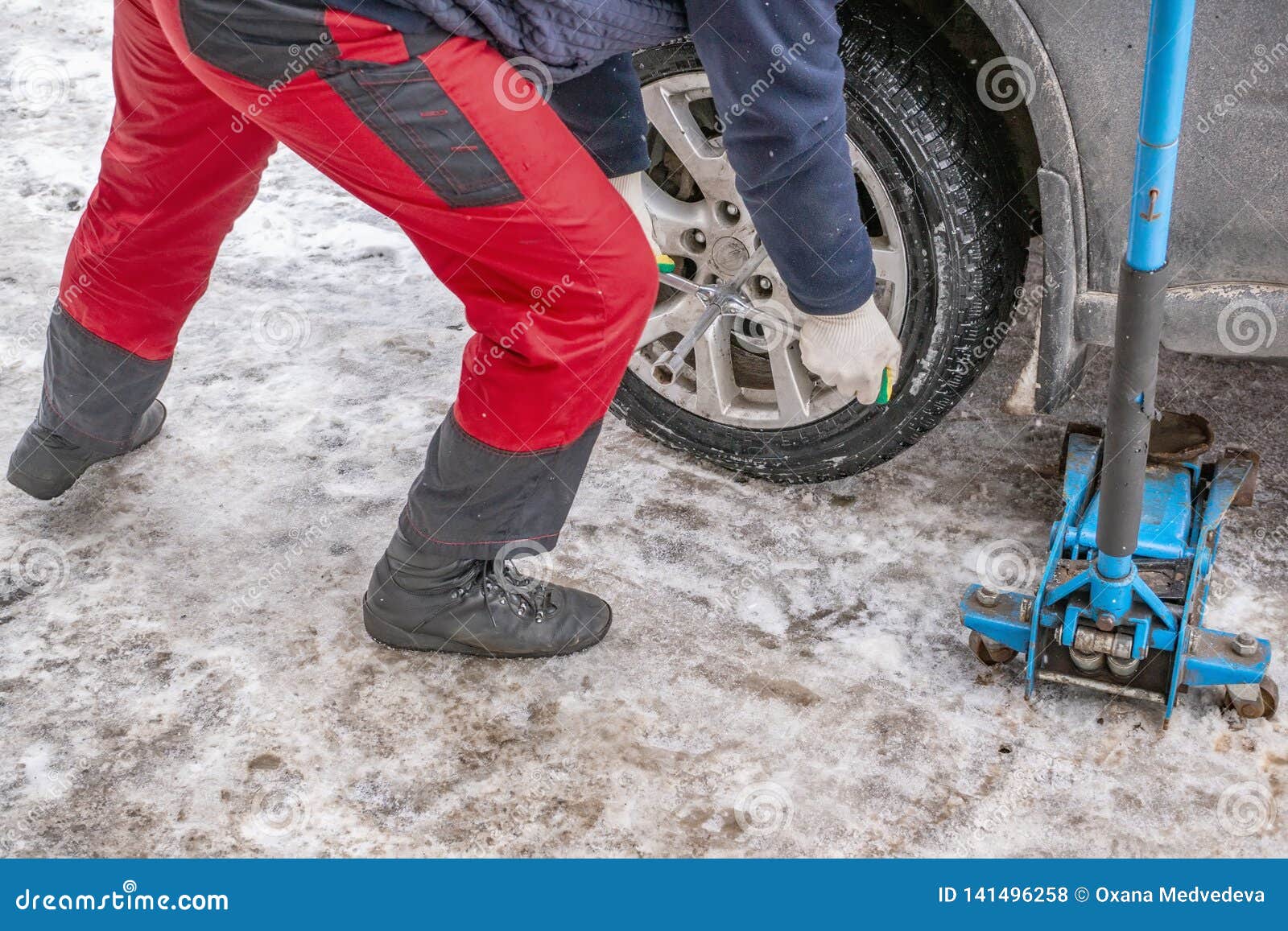The Working Process of Removing the Wheels from the Car on the Street ...