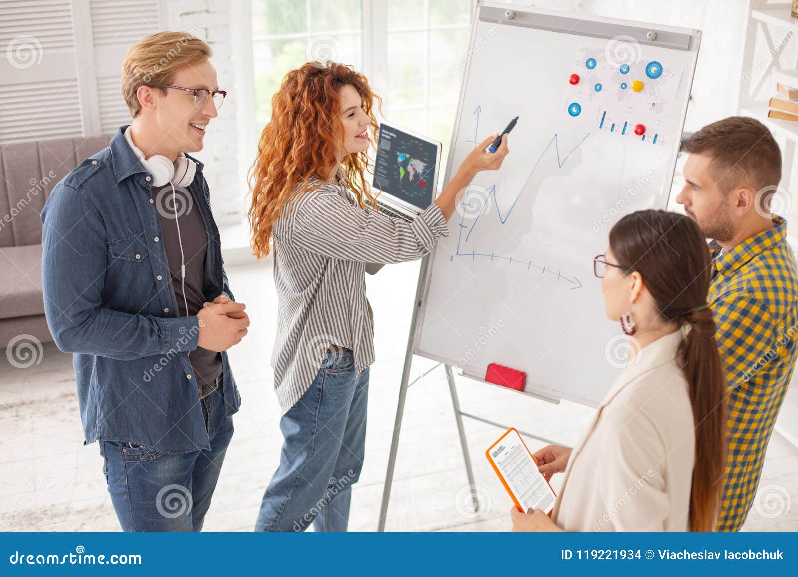 Optimistic Four Colleagues Examining Graphic Stock Photo - Image of ...