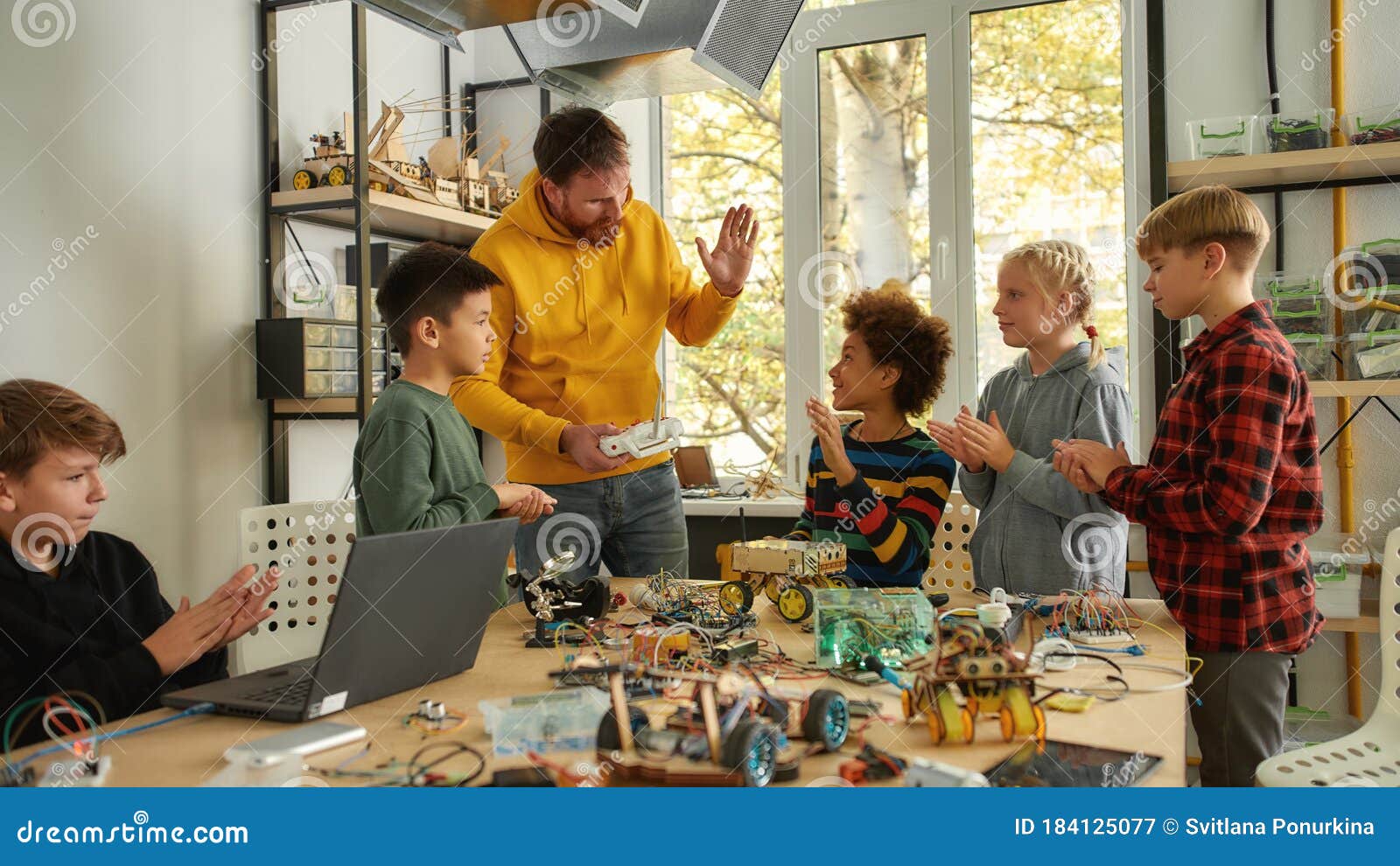 Working Process. Young Creative Male Teacher Explains for Students the ...