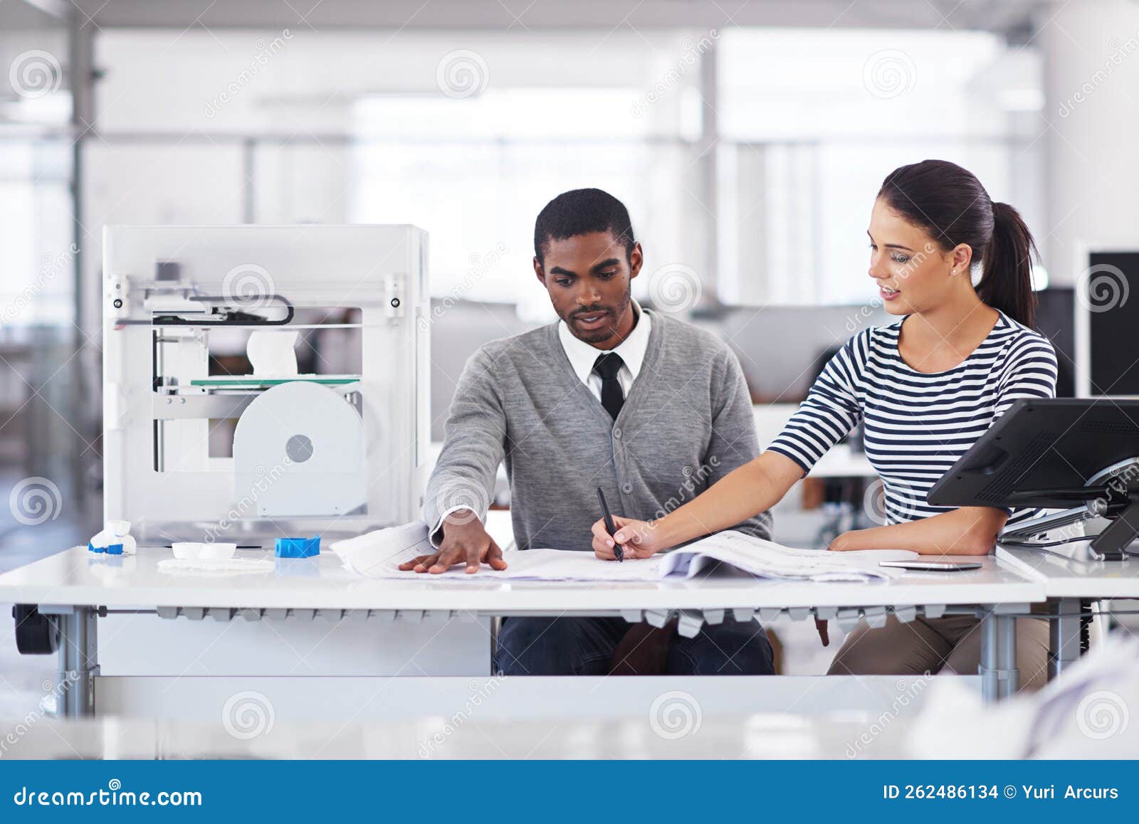 Working on Something Innovative. Two Colleagues Talking Together Over a ...