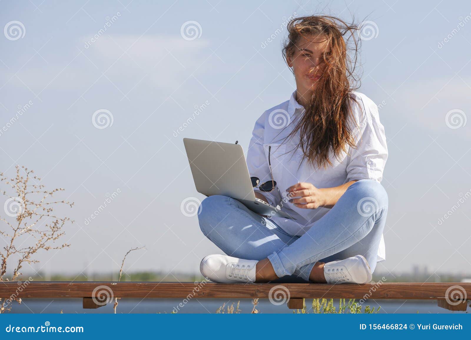 Working on Something with a Laptop in a Public Park Stock Photo - Image ...