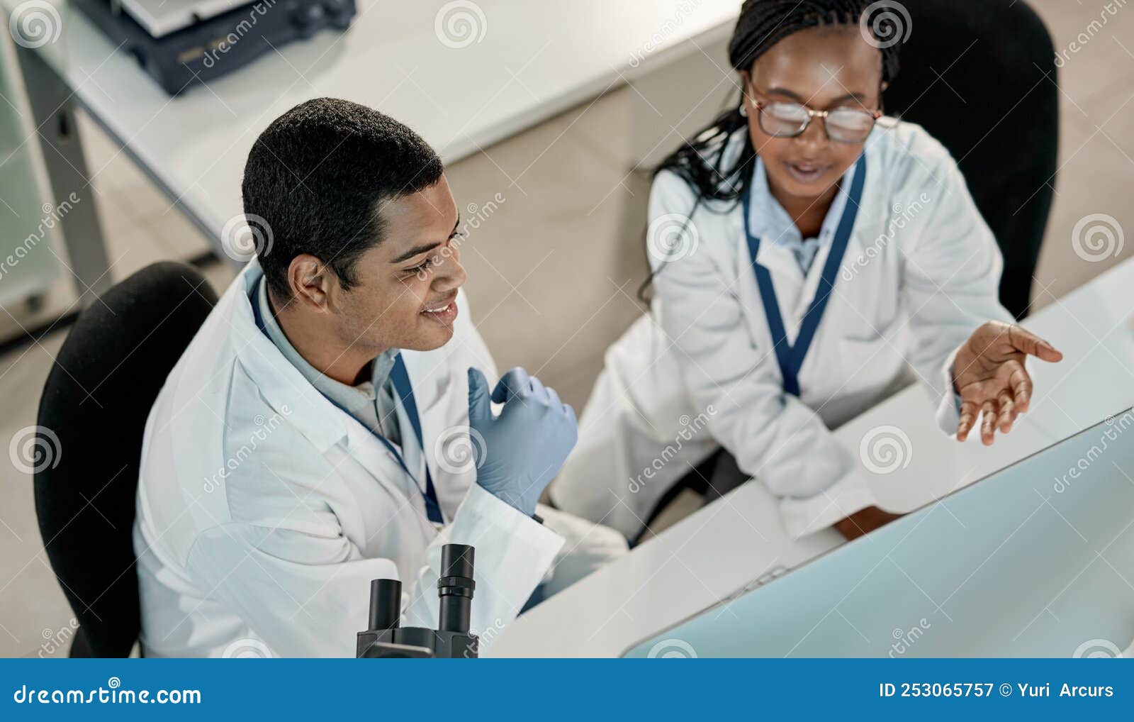 Working on Something New. Two Scientists Working Together on a Computer ...