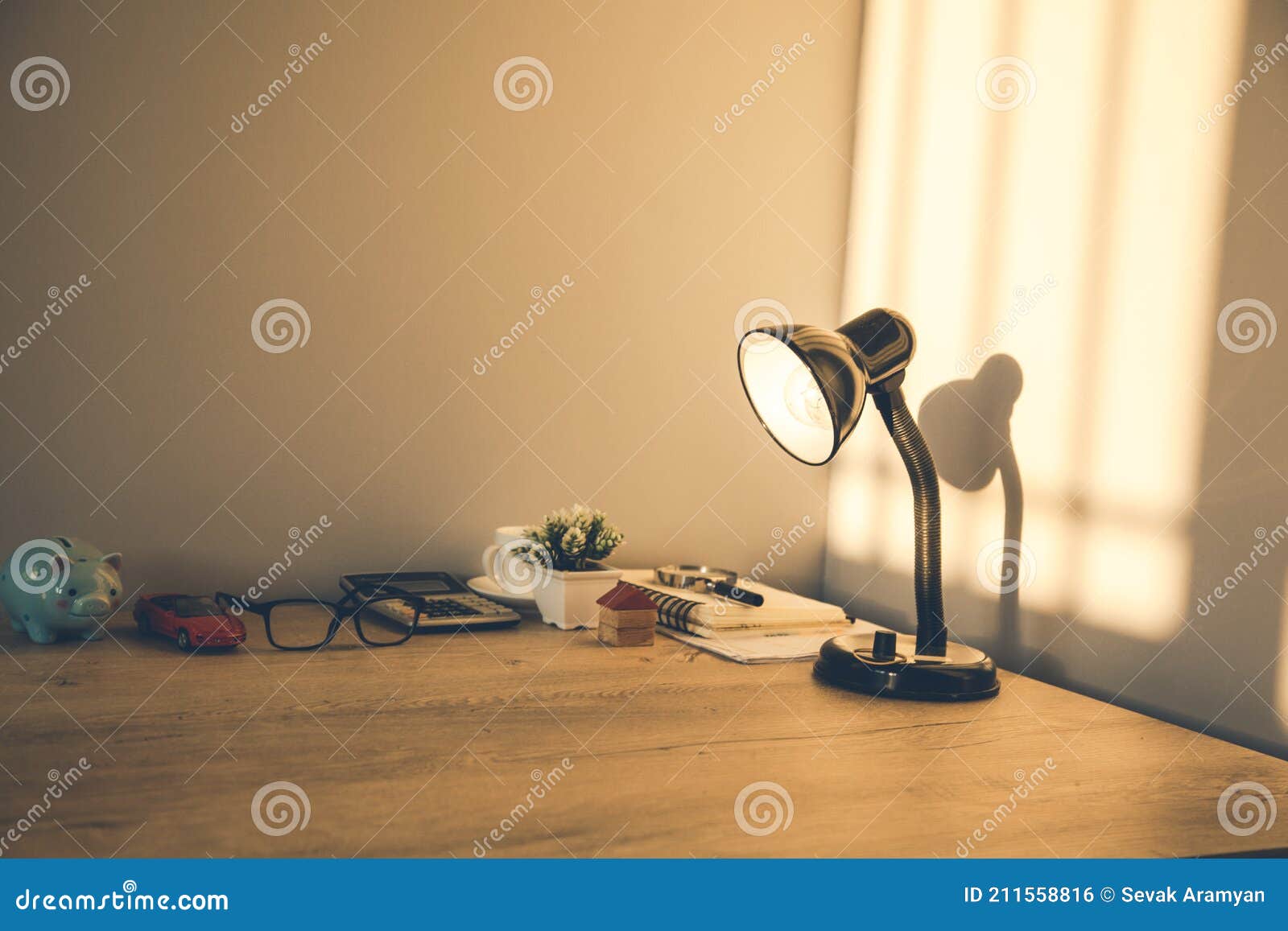 Working Table with Lamp on Wall Background in Evening. Stock Photo ...