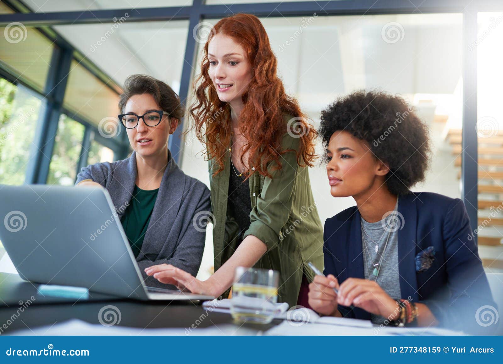 Working Their Magic Together. Three Young Creatives Working Together on ...