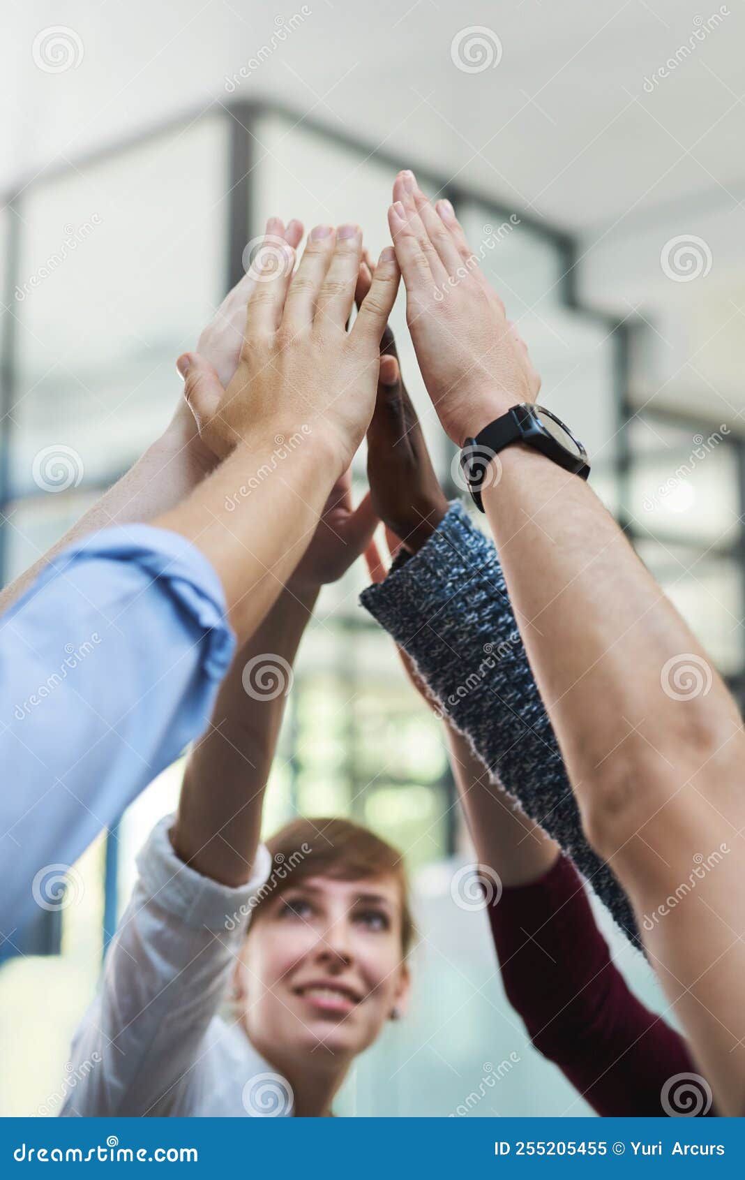 Working Together As One. a Group of People Putting Their Hands Up ...