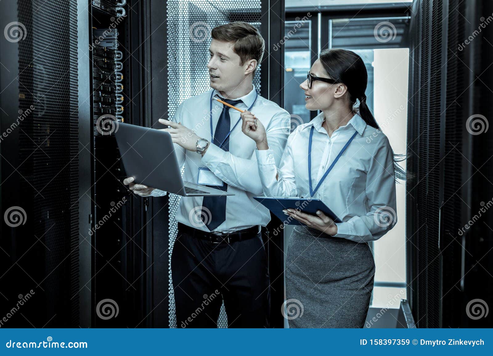 Two Security Guards in Eyeglasses Working Together with the Laptops ...