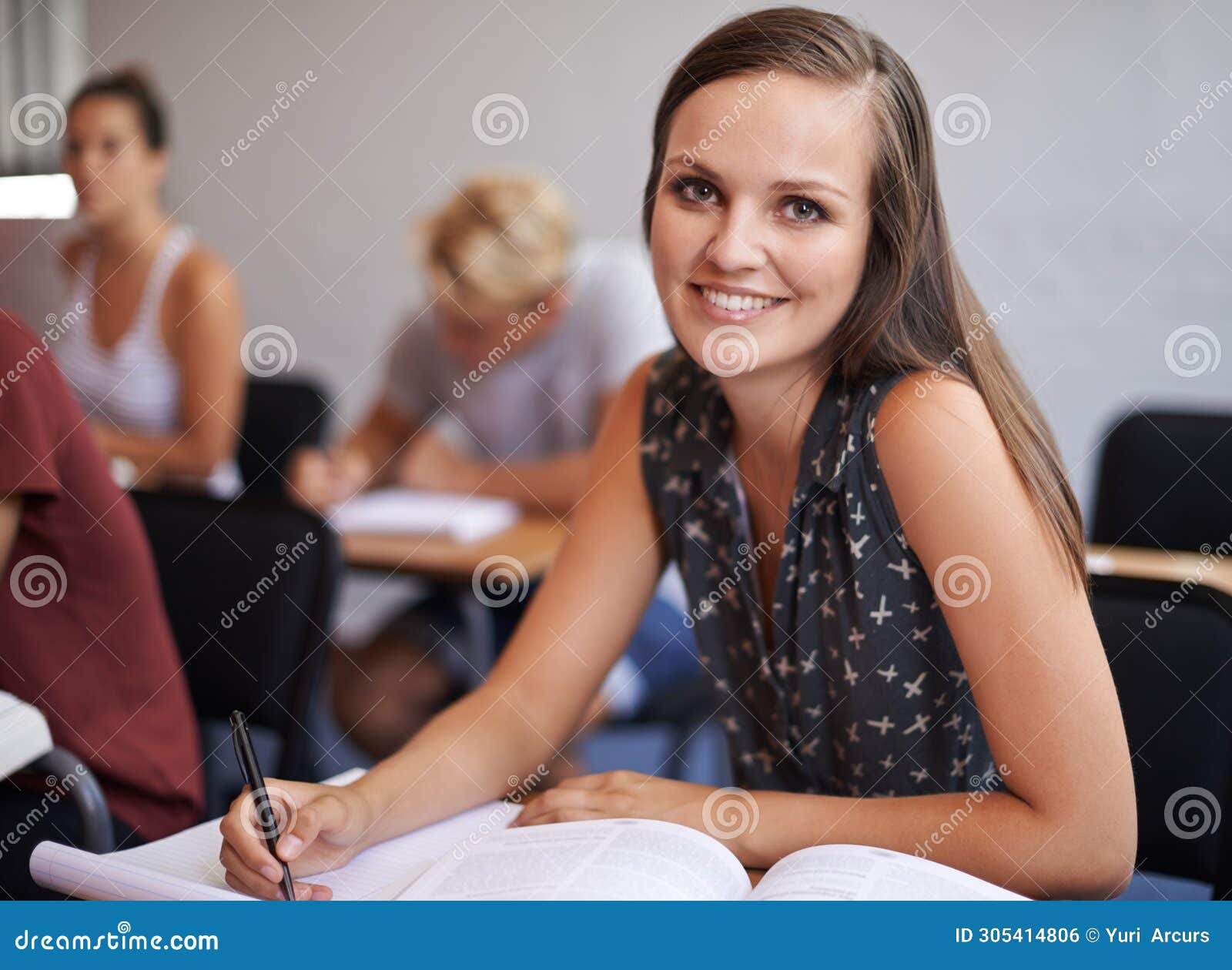 Working Toward an a. an Attractive Young Varsity Student Sitting in a ...