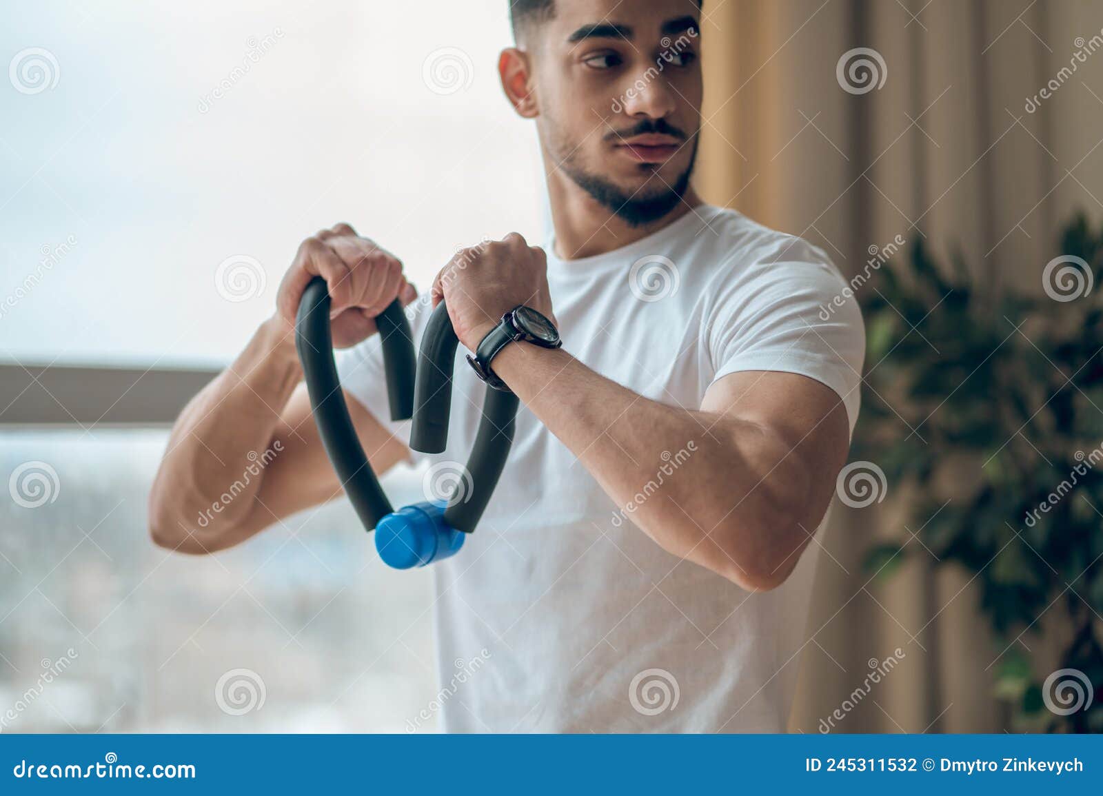 A Man in a White Tshirt Exercising with Expander Stock Photo - Image of ...