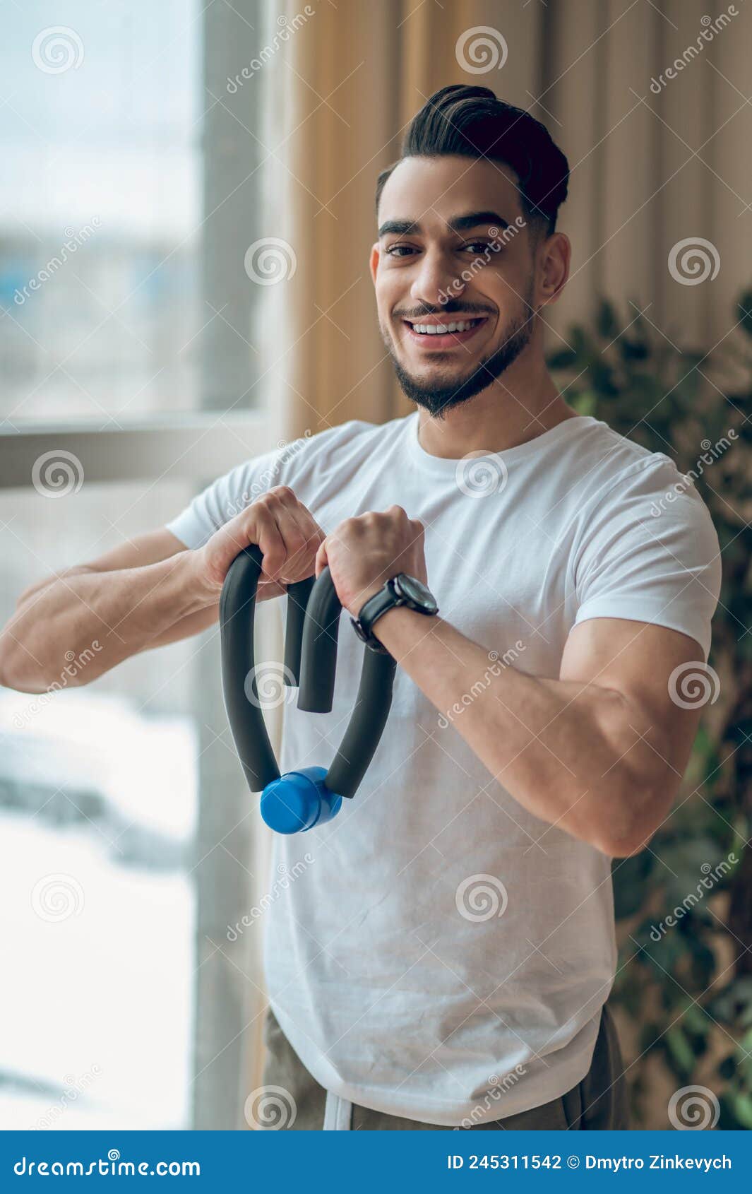 A Man in a White Tshirt Exercising with Expander Stock Photo - Image of ...