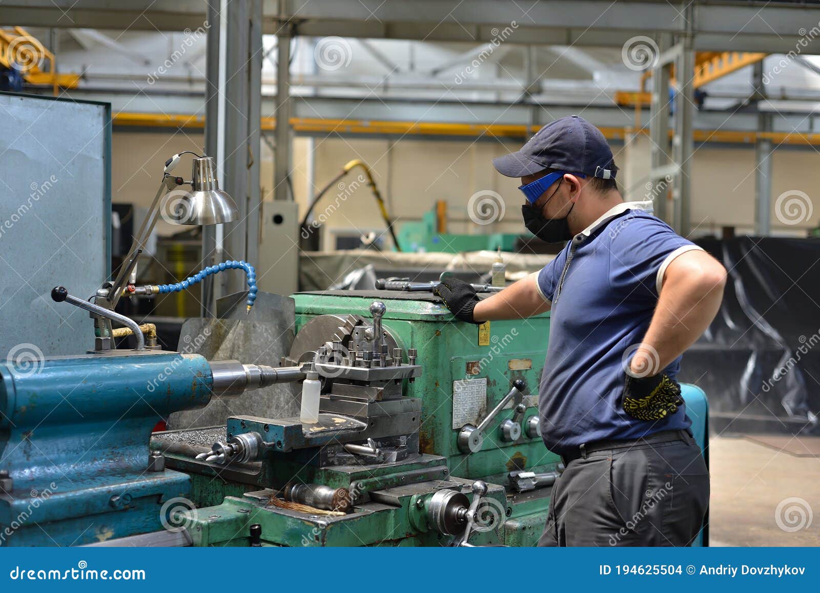 Working Turner Wearing a Protective Antiviral Mask on a Lathe in a ...