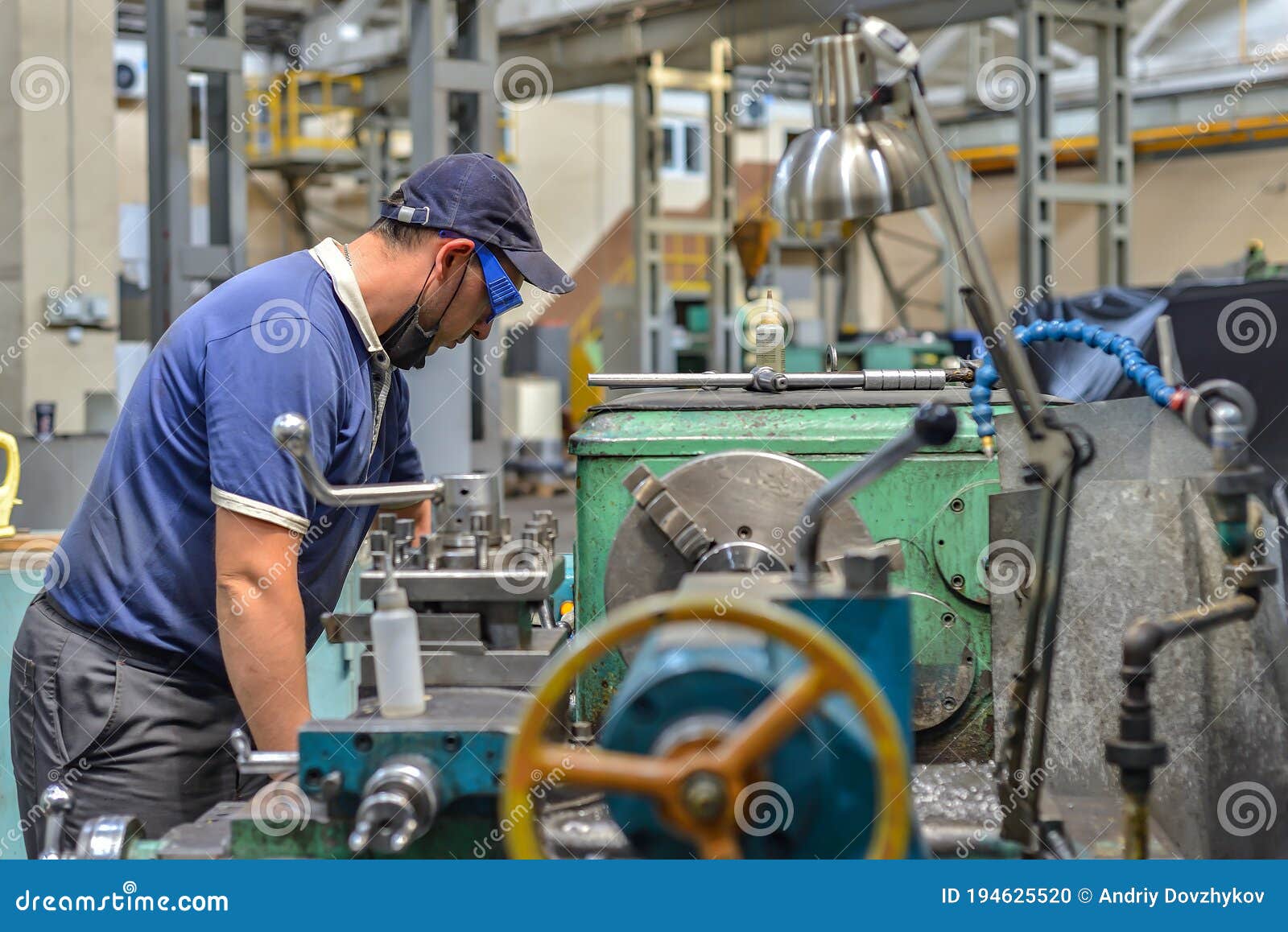Working Turner Wearing a Protective Antiviral Mask on a Lathe in a ...
