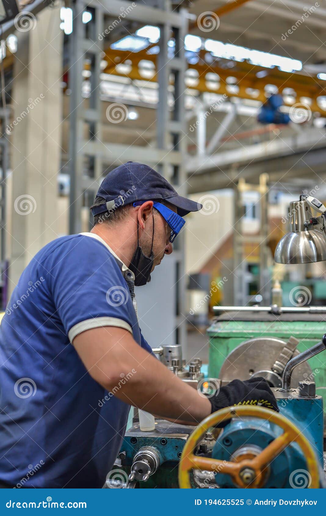 Working Turner Wearing a Protective Antiviral Mask on a Lathe in a ...