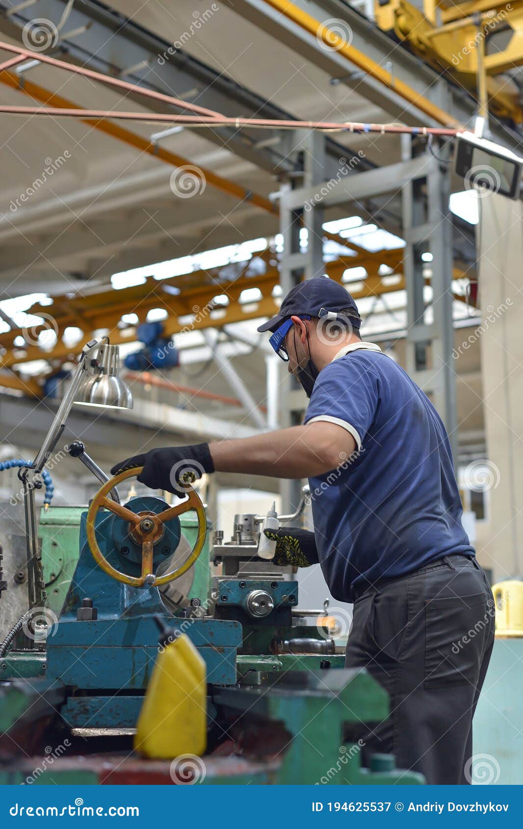 Working Turner Wearing a Protective Antiviral Mask on a Lathe in a ...