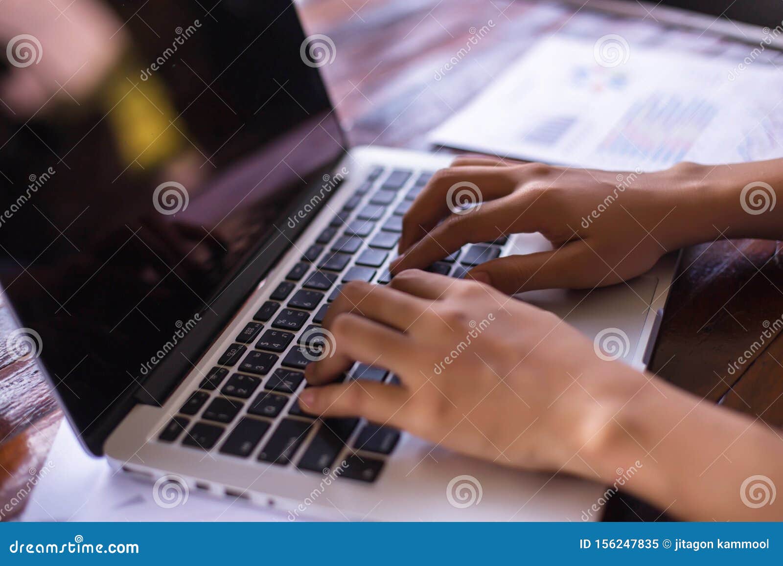Working by Using a Laptop Computer on Wooden Table. Hands Typing on a ...
