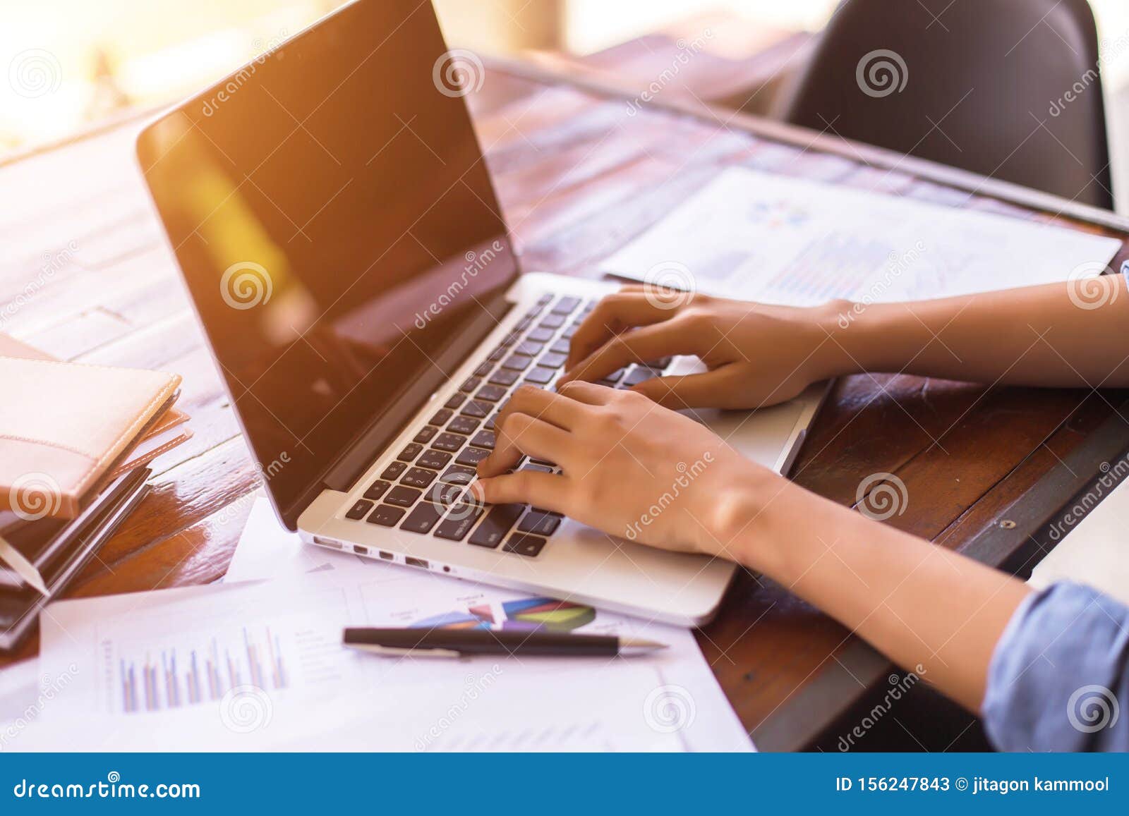 Working by Using a Laptop Computer on Wooden Table. Hands Typing on a ...