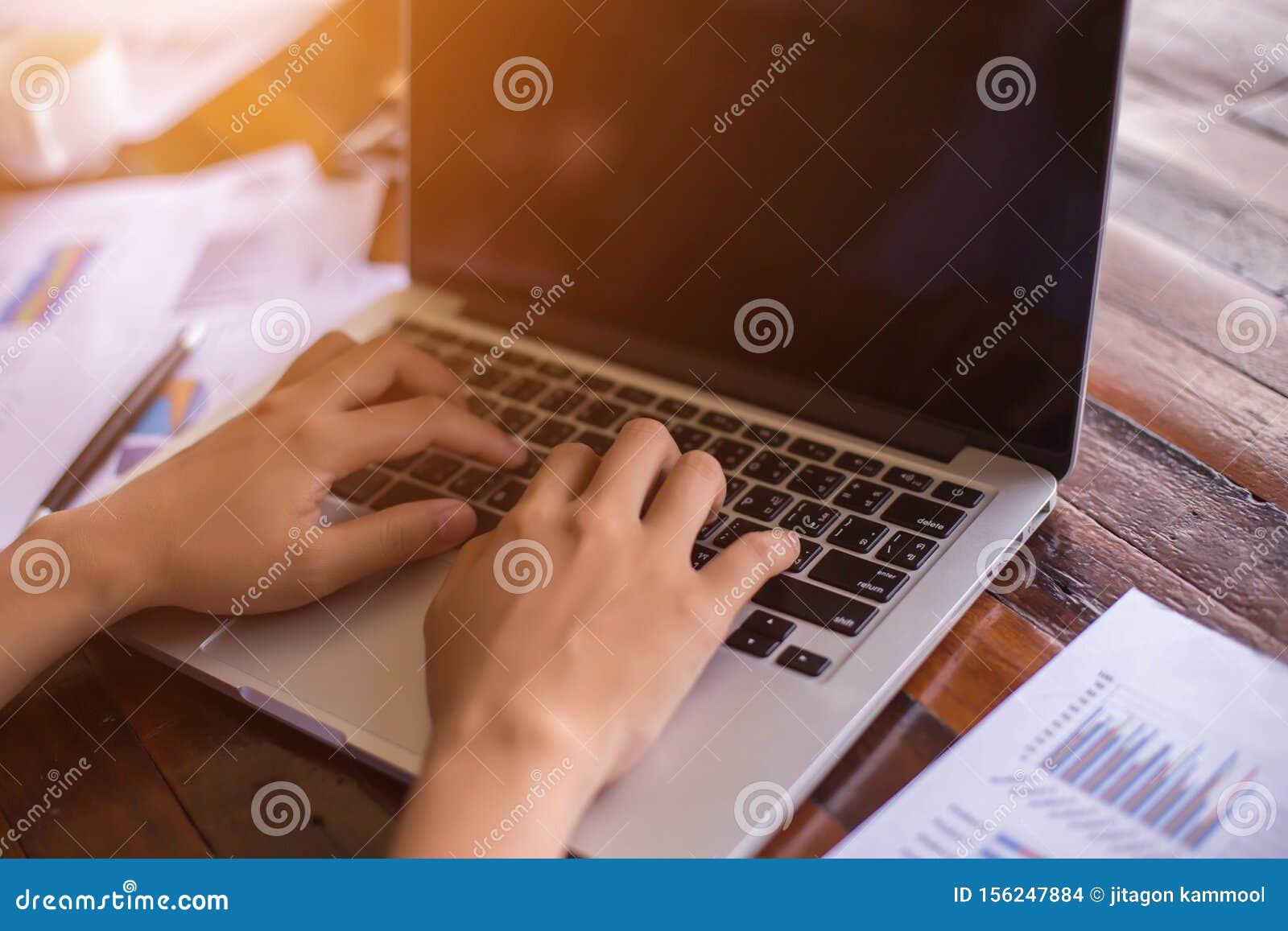 Working by Using a Laptop Computer on Wooden Table. Hands Typing on a ...