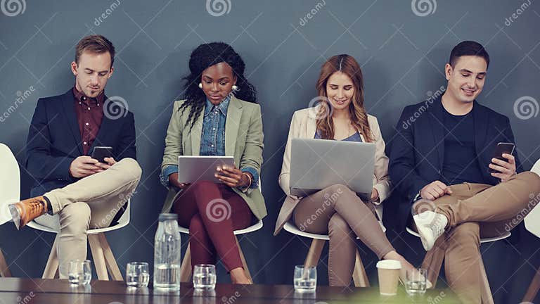 Working while we Waiting. a Group of Businesspeople Using Different ...