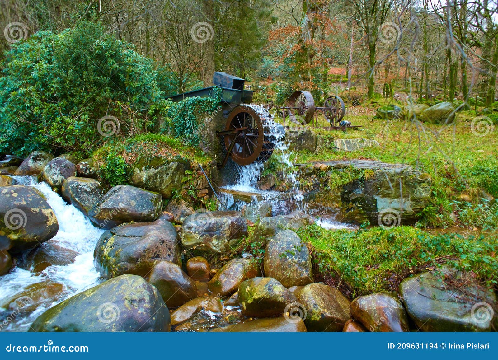 Working Water Mill Wheel with Falling Water in the Village. Stock Photo ...