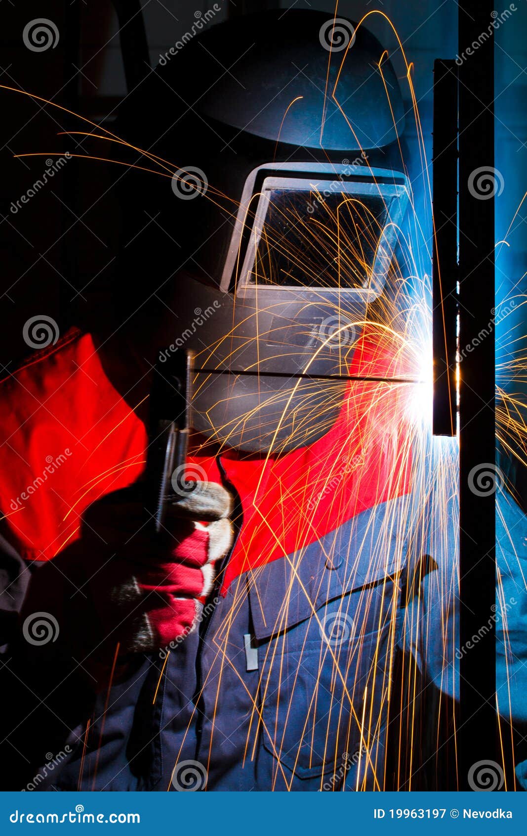 The Working Welder Performs Welding Work In Production Using Electric ...