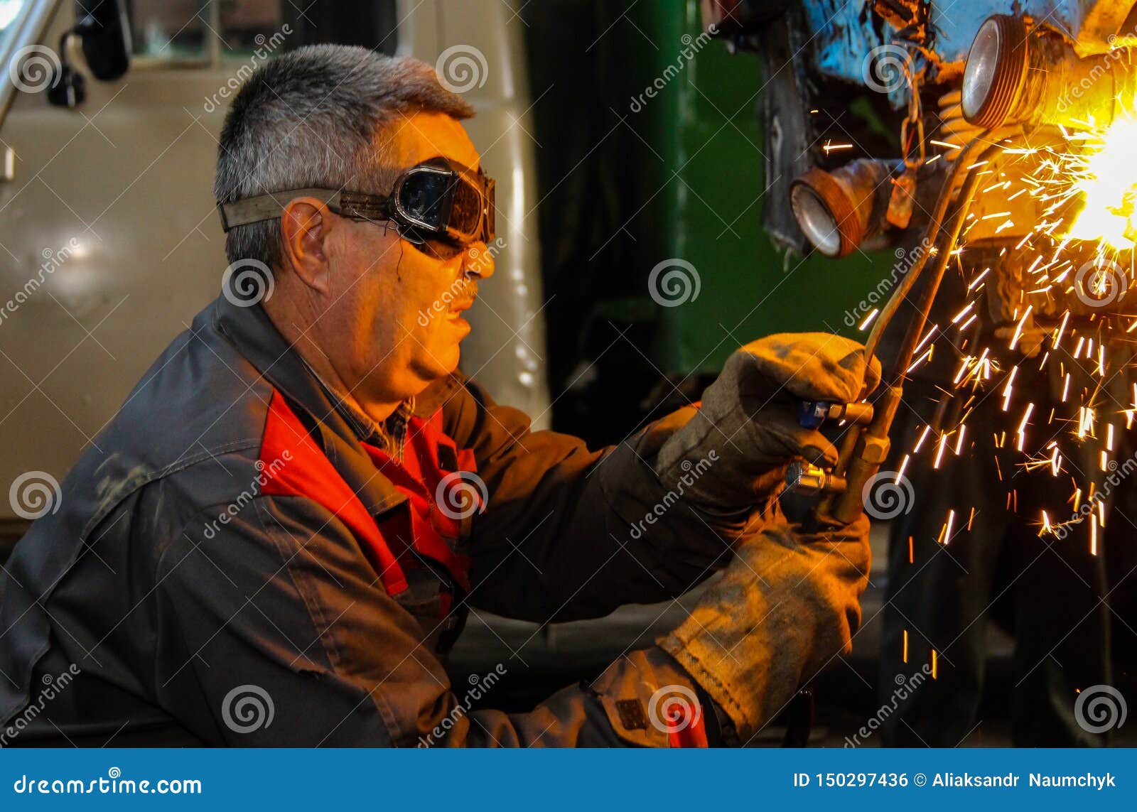 The Working Welder Performs Welding Work in Production Using Electric ...