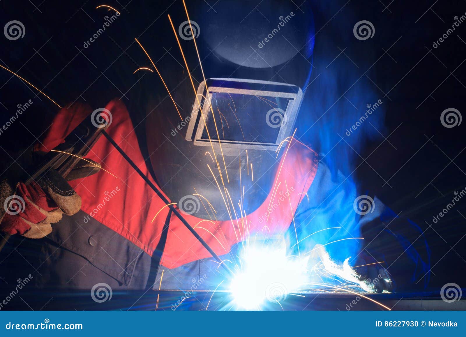 The Working Welder Performs Welding Work In Production Using Electric ...